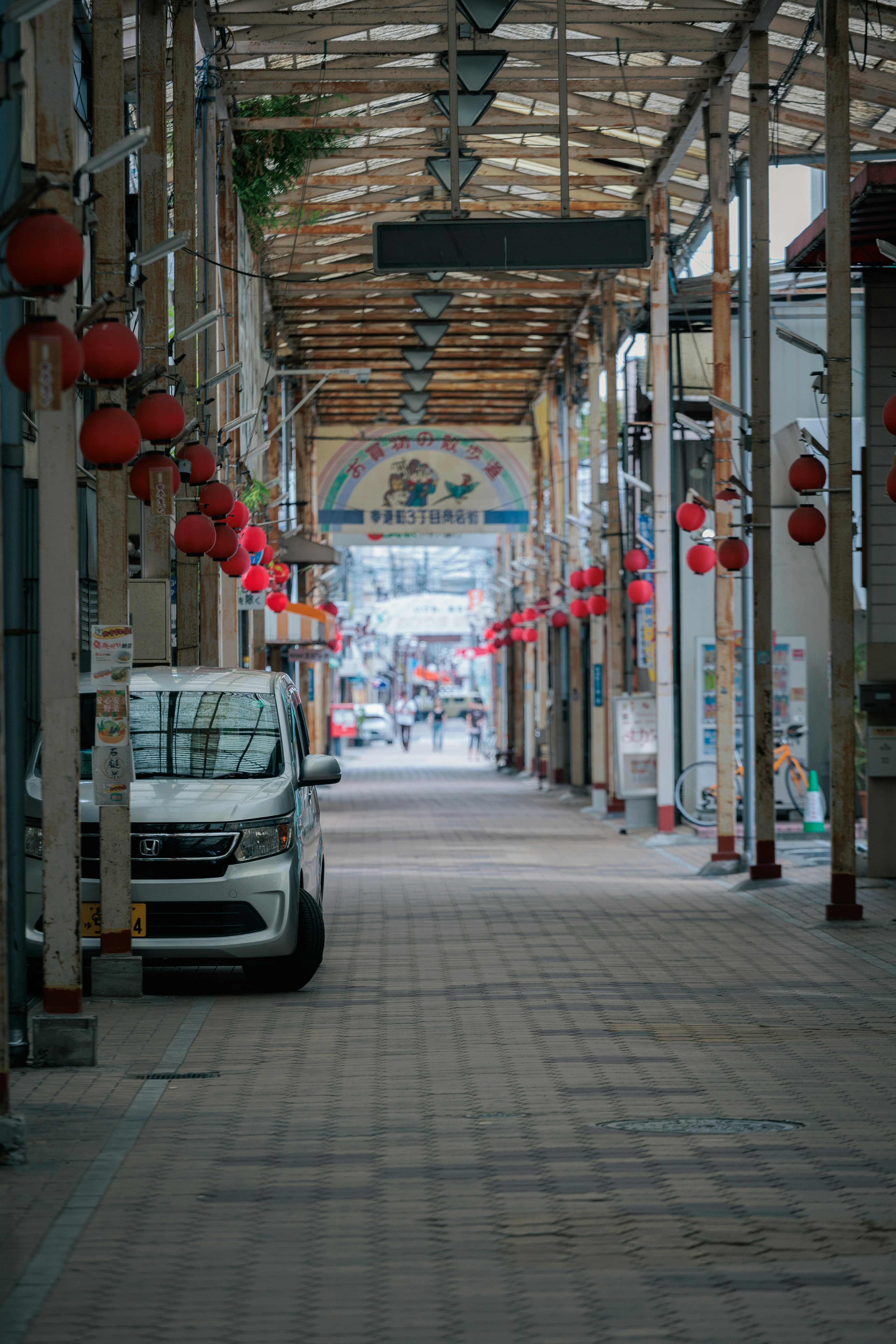 Lantern-lined Alleyscape: The Street Through a Market Arch