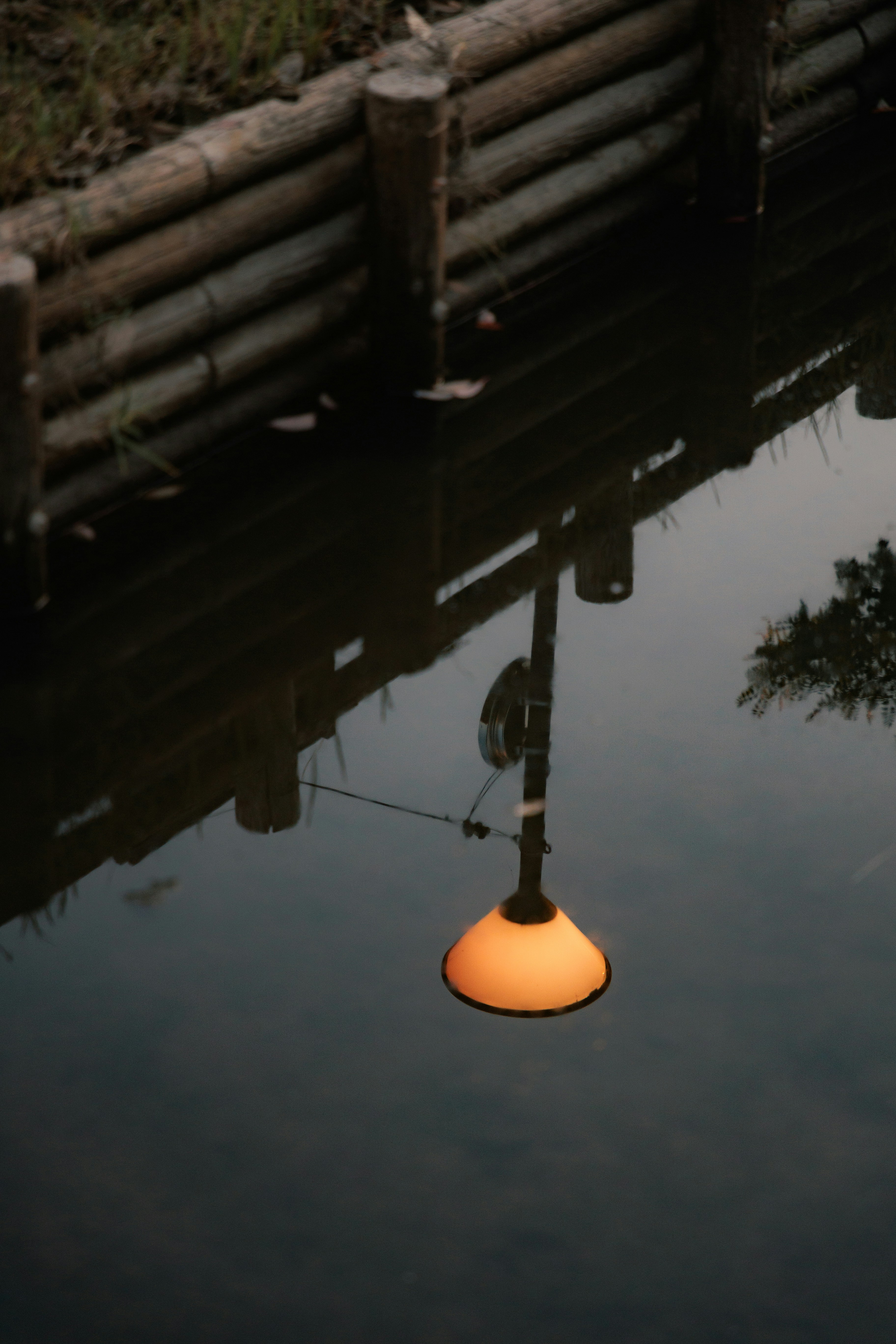 Amber Lantern Reflected on a Quiet Waterway