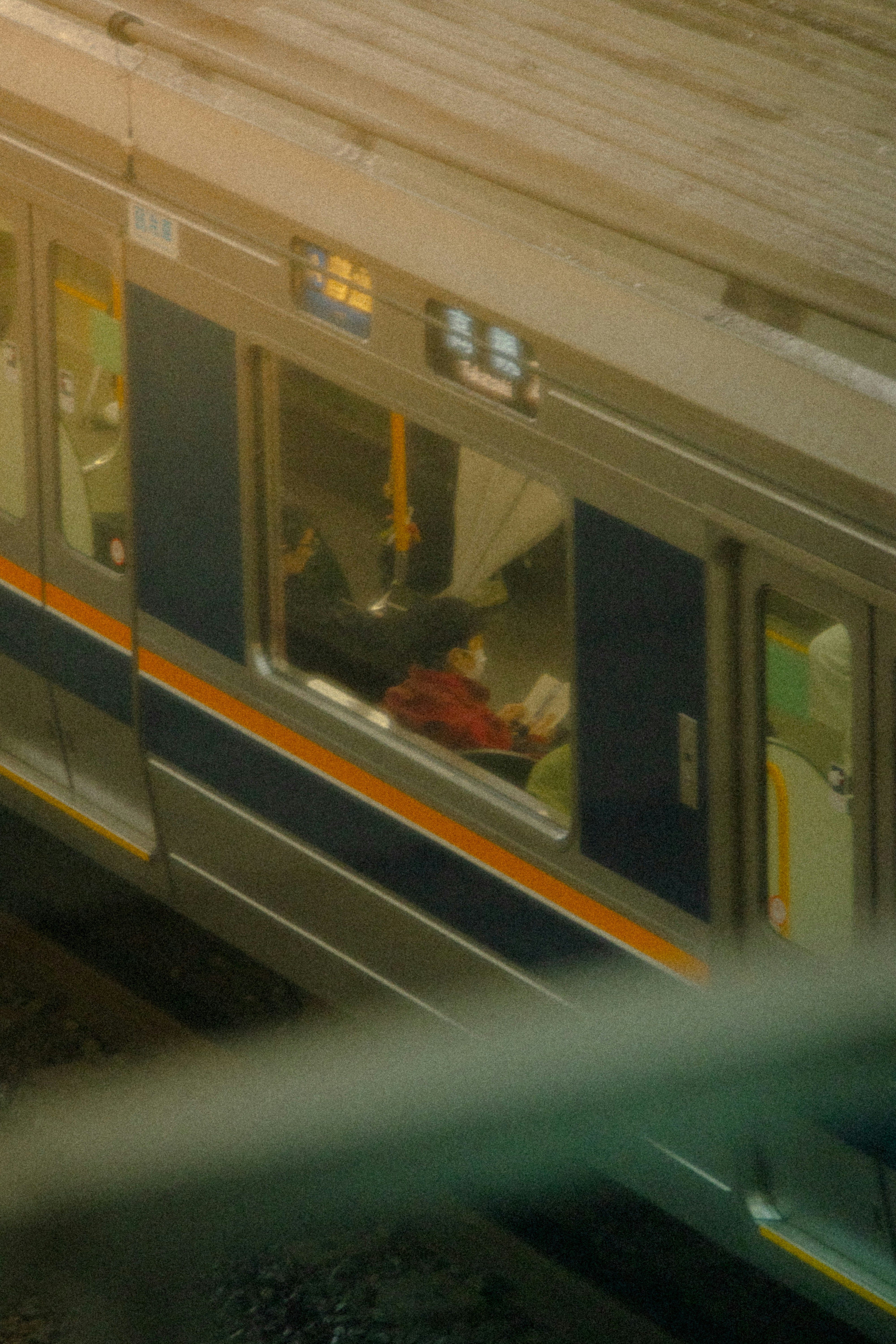 Red-Clad Quiet Inside a Moving Car: Aerial Glimpse of a Commuter