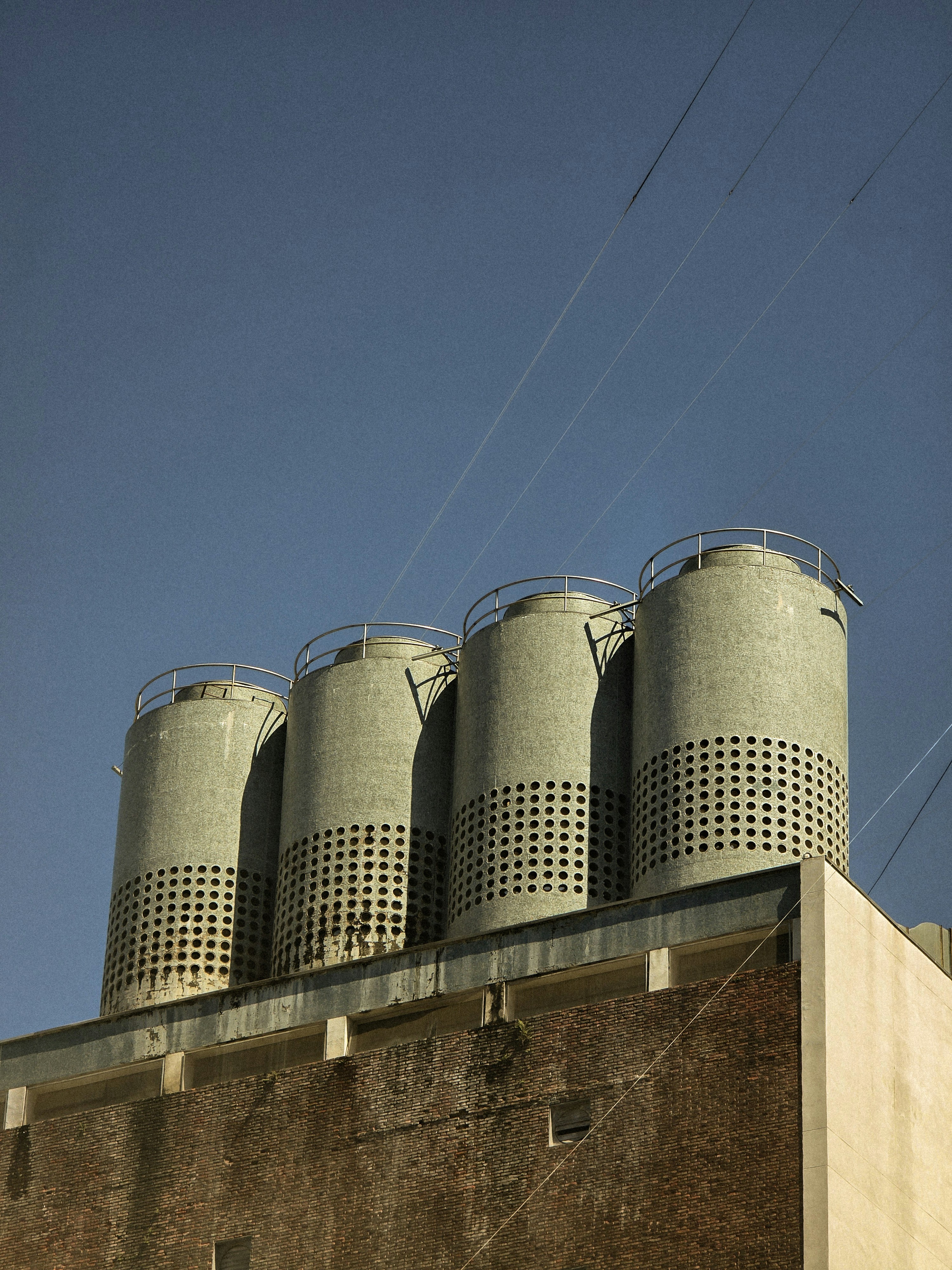 A tall building with four silos on top of it photo – Free Buenos aires ...