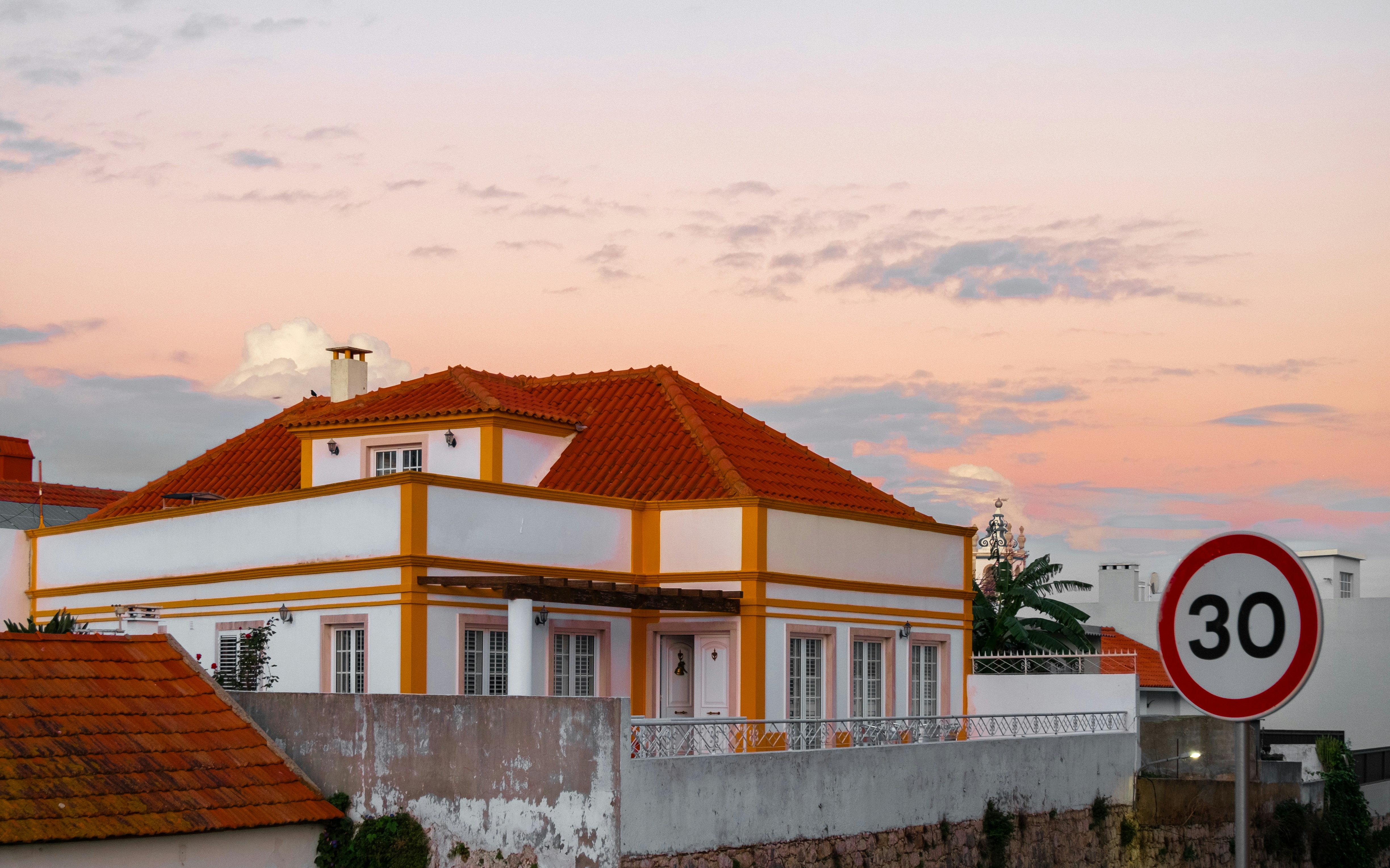 Orange-Trim Villa on a Quiet Street Under Peachy Dusk