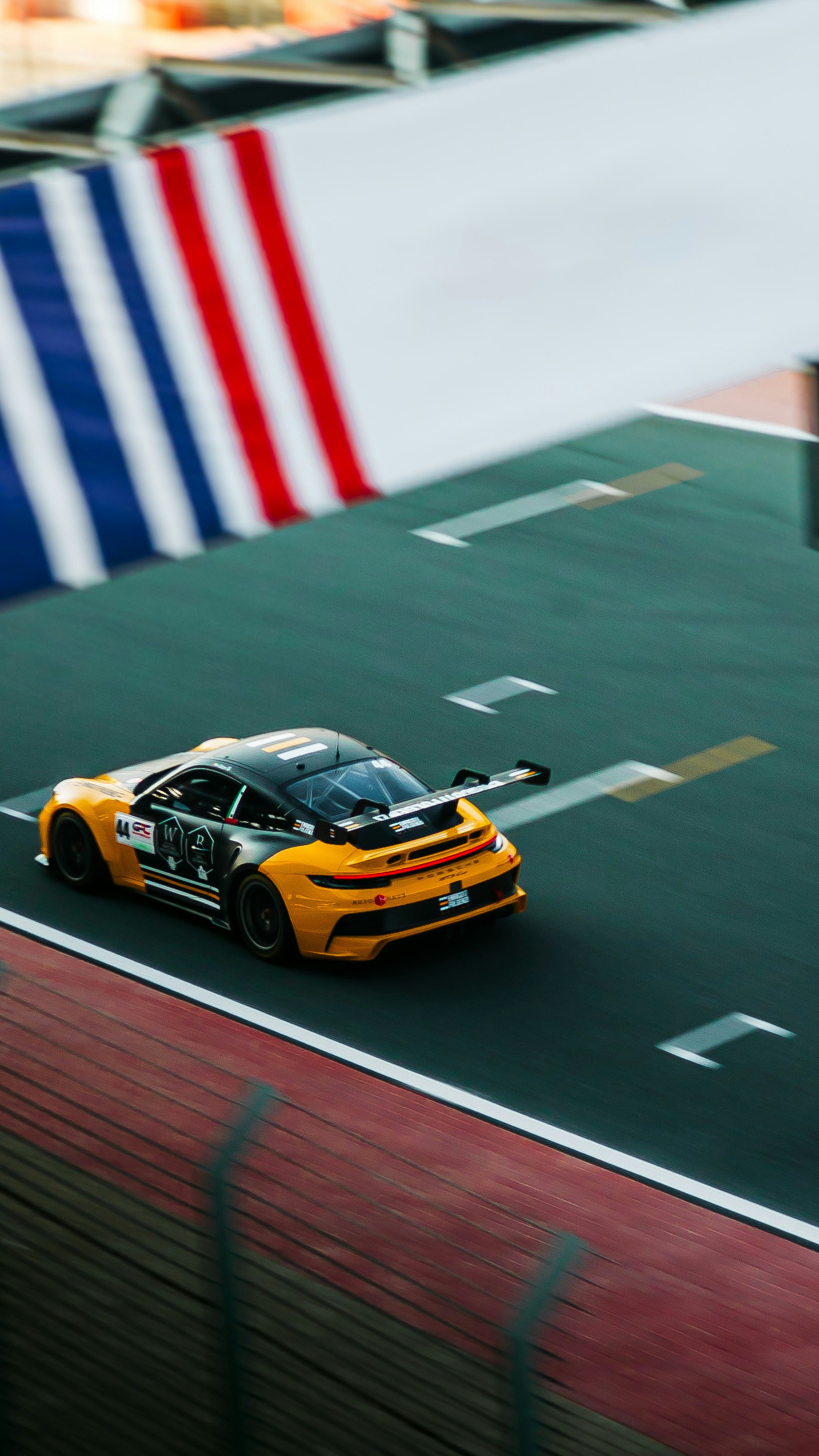 Yellow GT Racer Cuts Through Blur on the Race Circuit