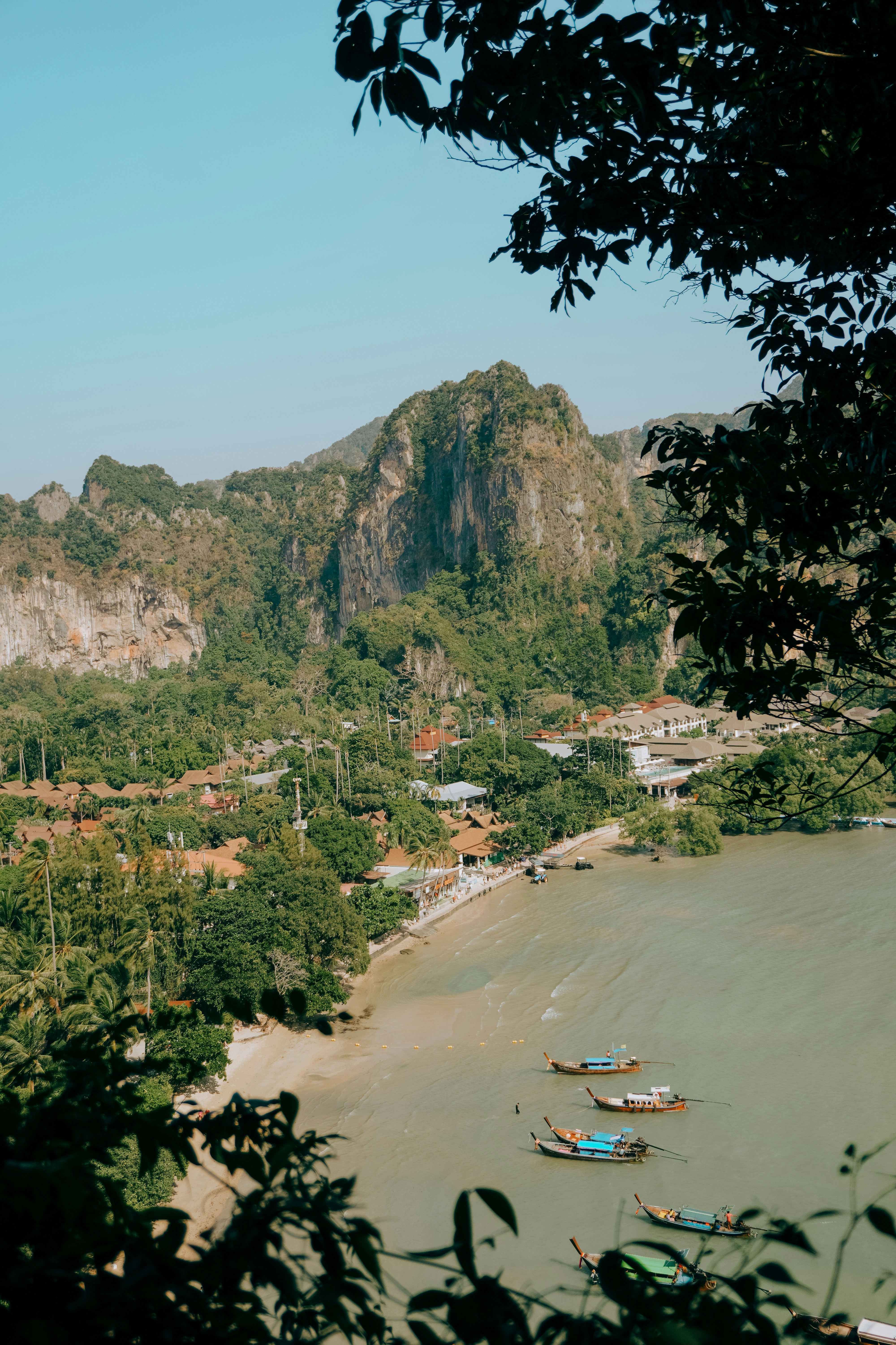 Boats Rest at a Sunlit Cove Framed by Limestone Cliffs