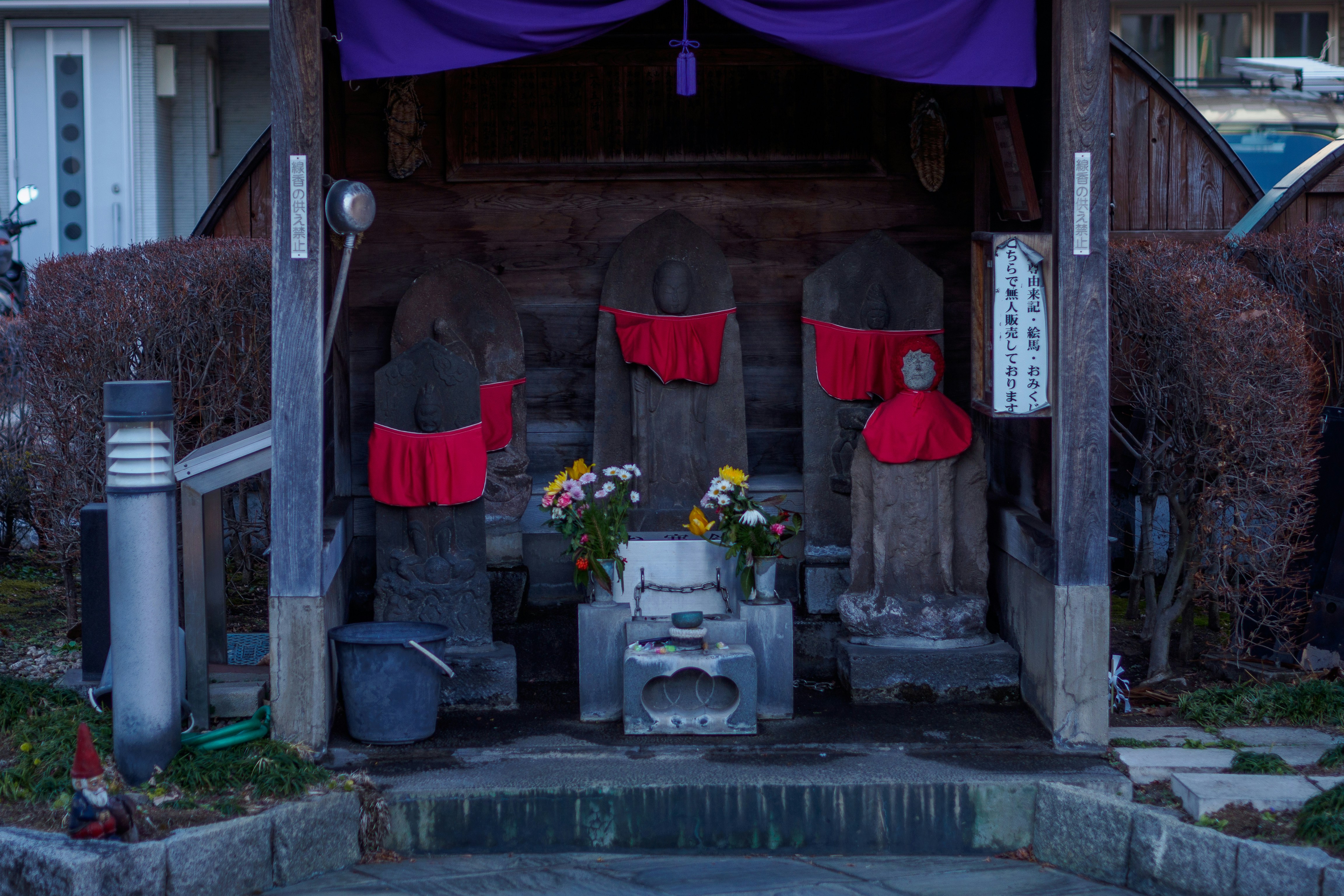 The statues resemble Jizo, also called O-Jizo-san or O-Jizo-sama, the guardian deity of children and travelers. The primary role of Jizo is to protect children. Many Jizo statues wear red bibs and hoods. Since ancient times in Japan, red has been believed to ward off evil. Thus, some people put red bibs and hoods on Jizo to protect this guardian deity, and others who have lost their baby pray that the spirits can go to heaven without suffering.