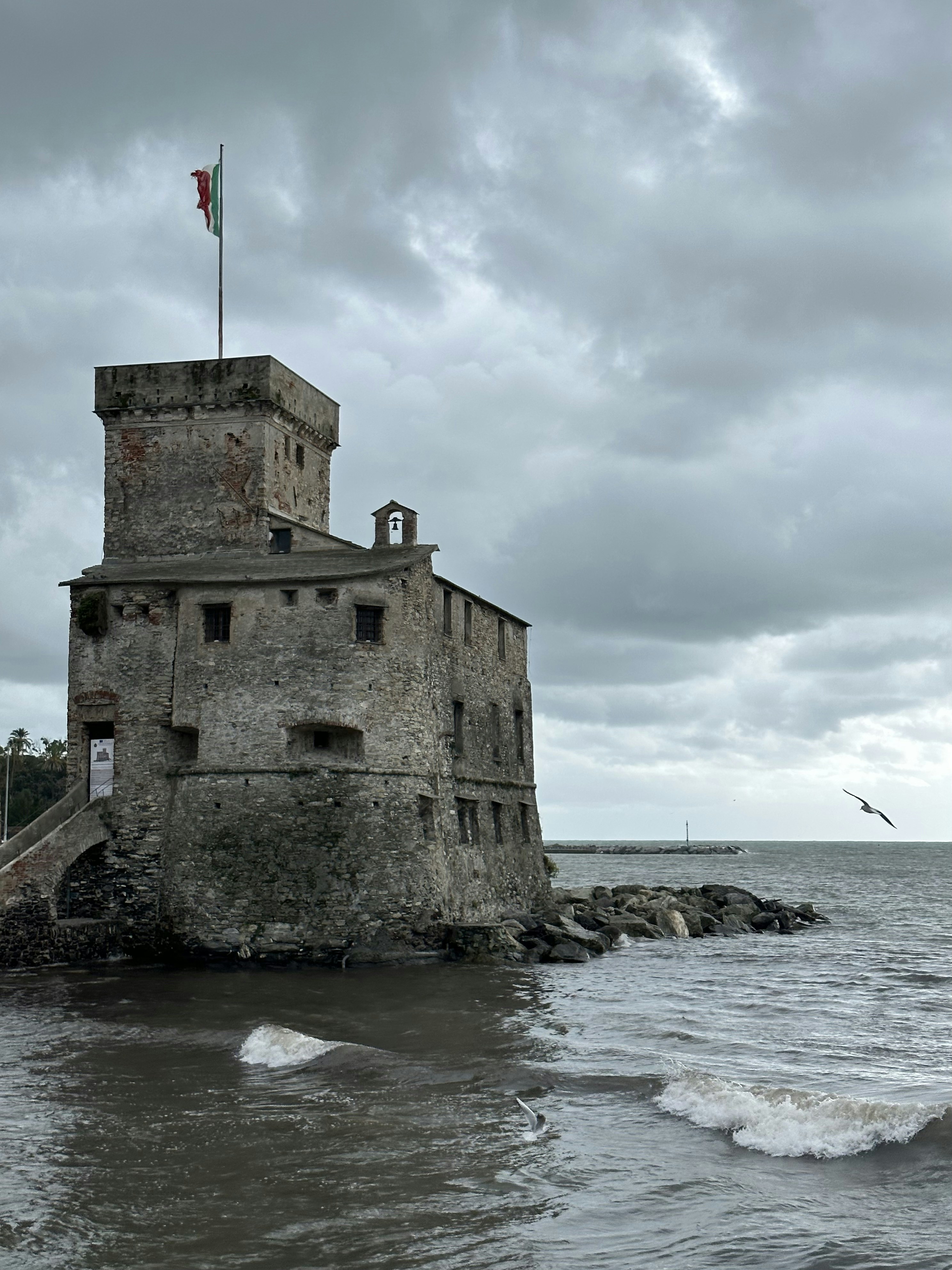 Sea-Front Fortress: Weathered Stone Sentinel Beside Grey Waves