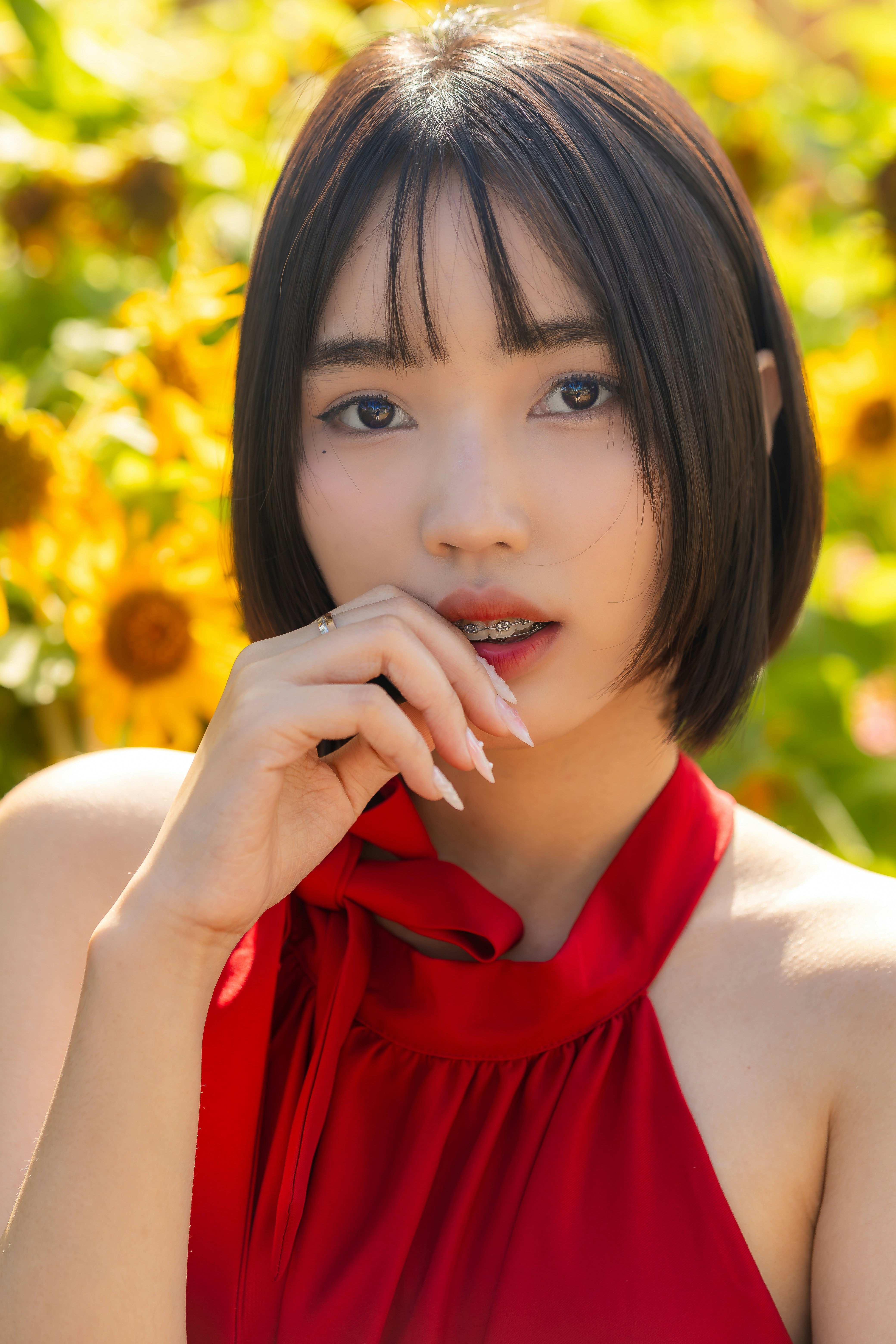 A woman in a red dress posing for a picture photo – Free Face Image on ...