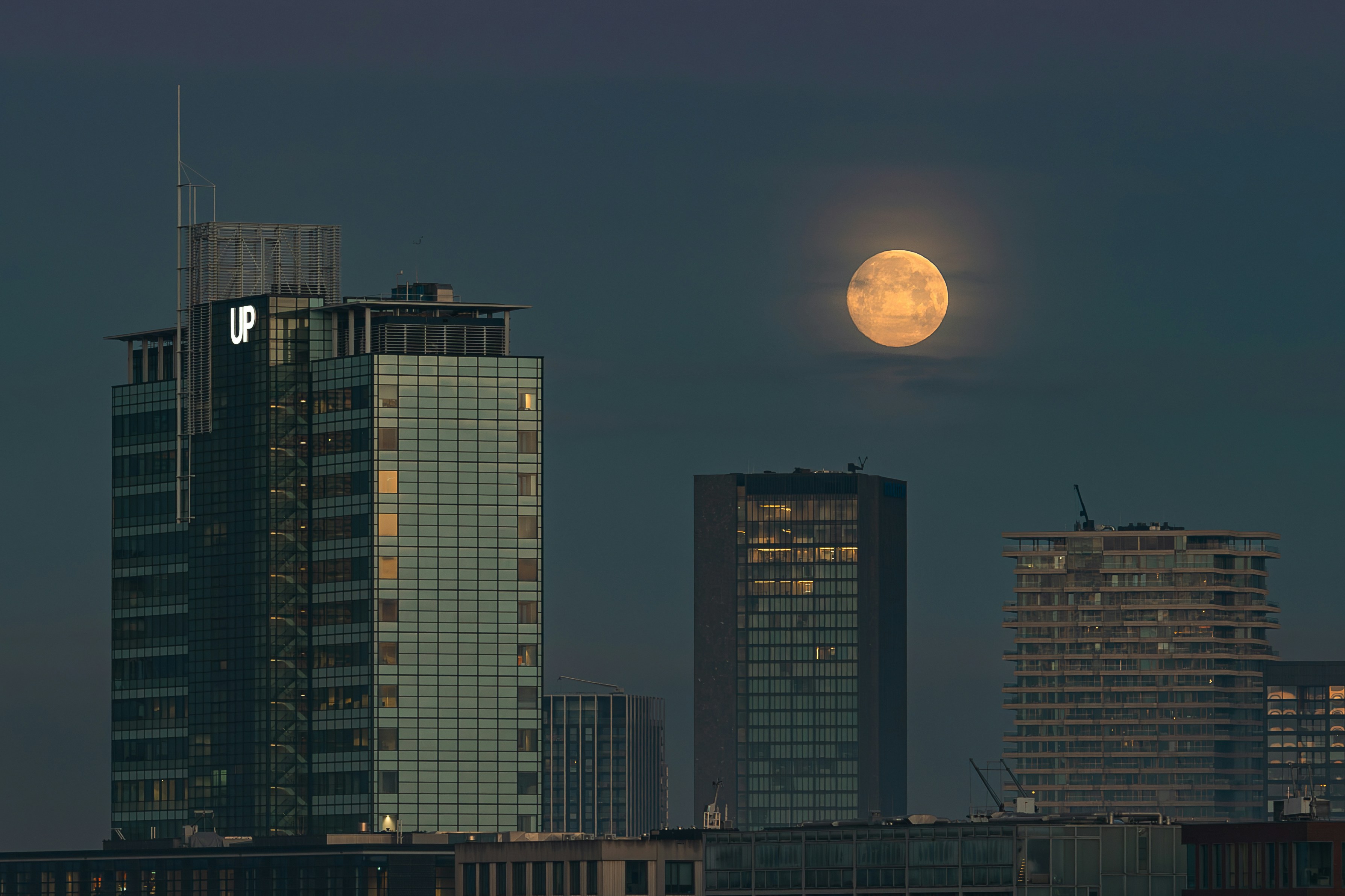 A full moon rises over a city skyline photo – Free Amsterdam Image on ...