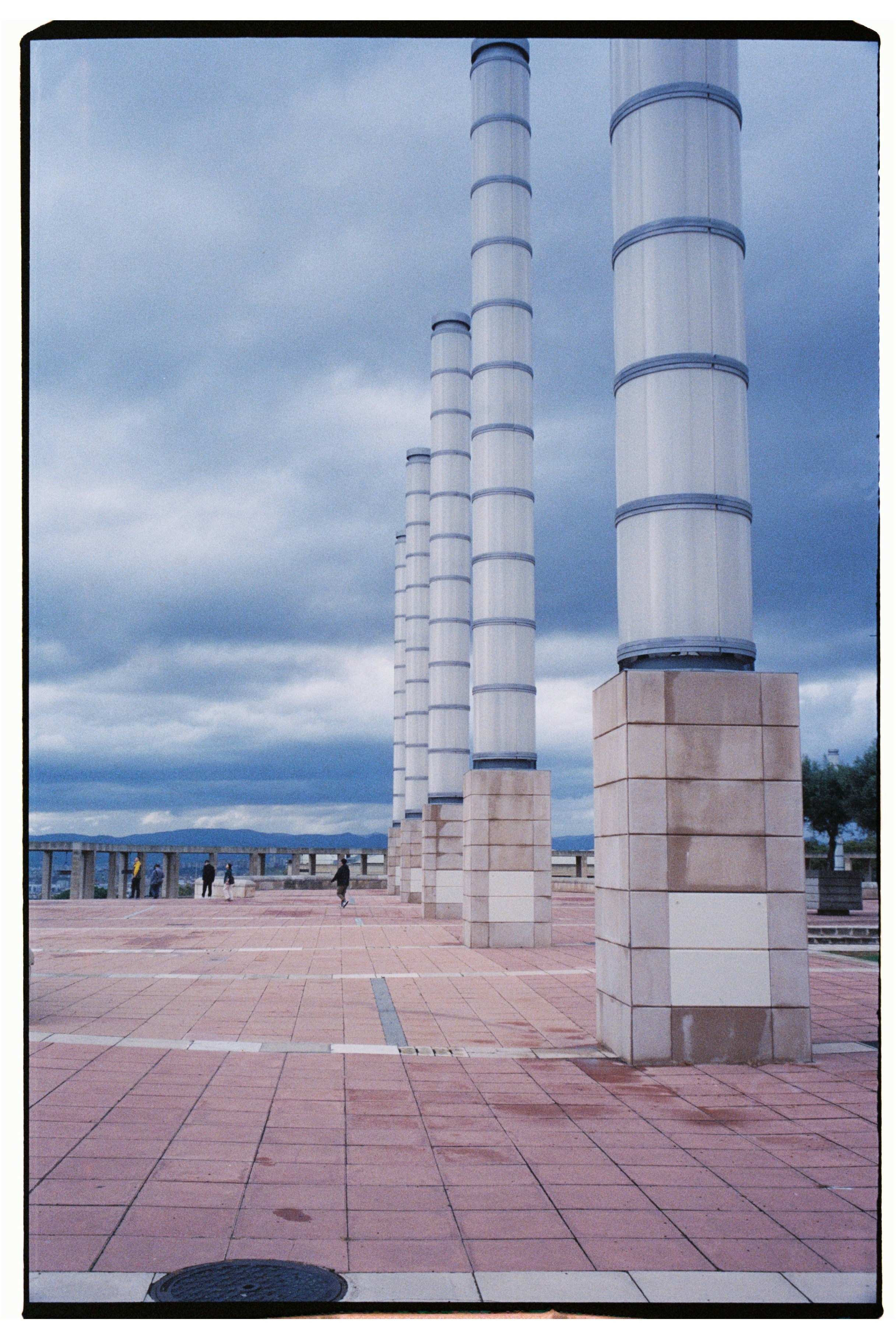Seaside Colonnade: Pillars marching toward a clouded horizon