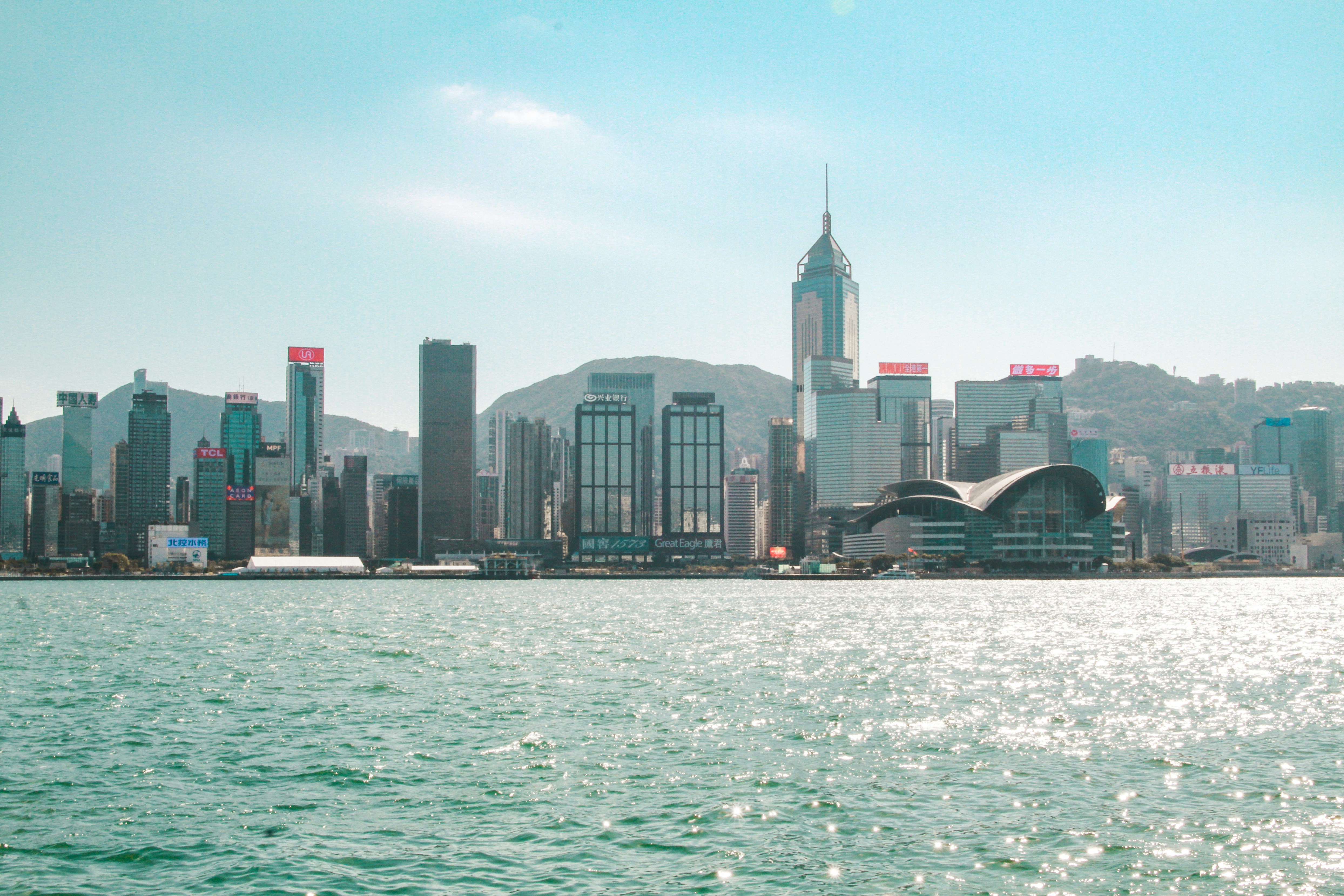 A large body of water with a city in the background photo – Free City ...