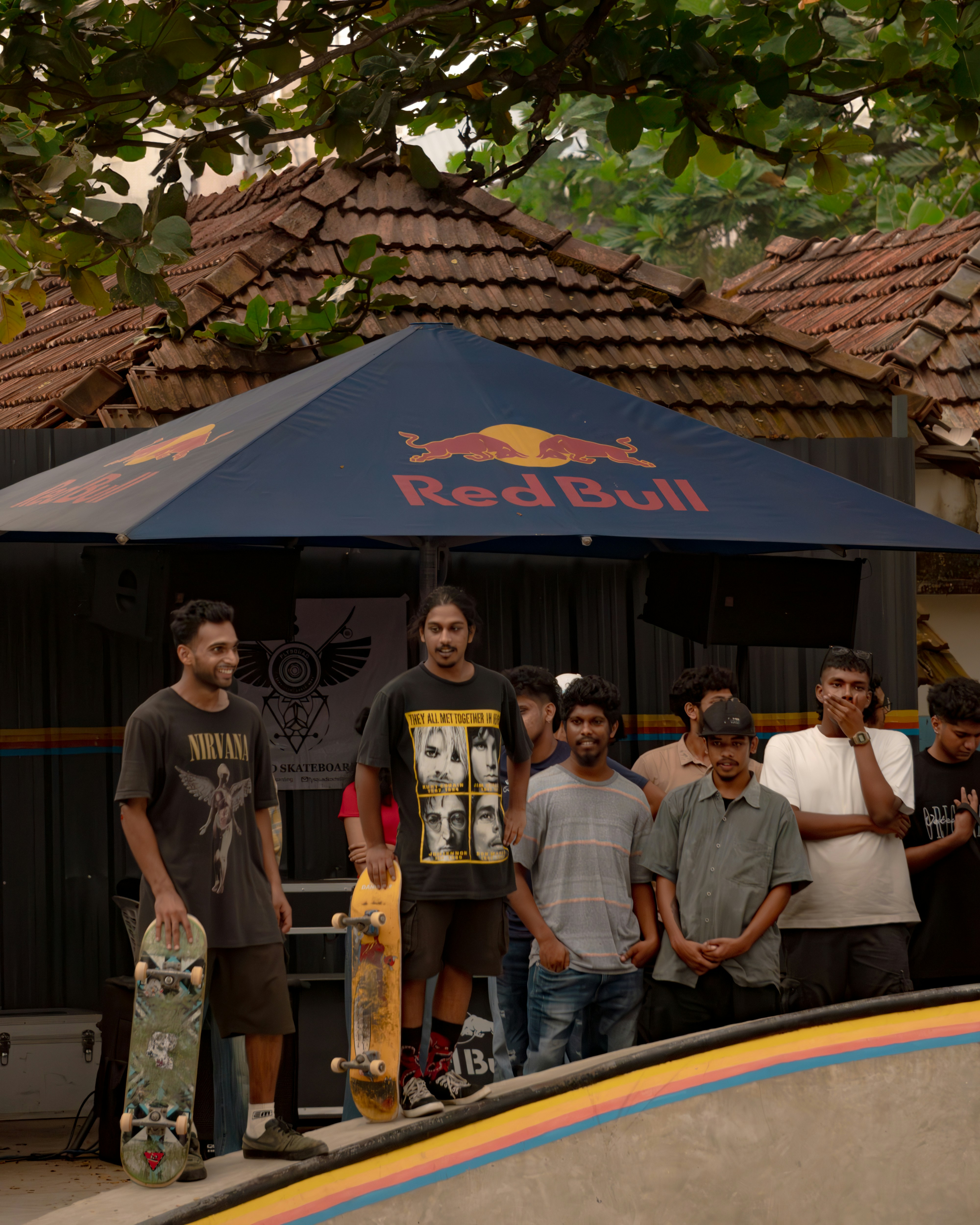 A group of young men standing around a skateboard ramp photo – Free ...