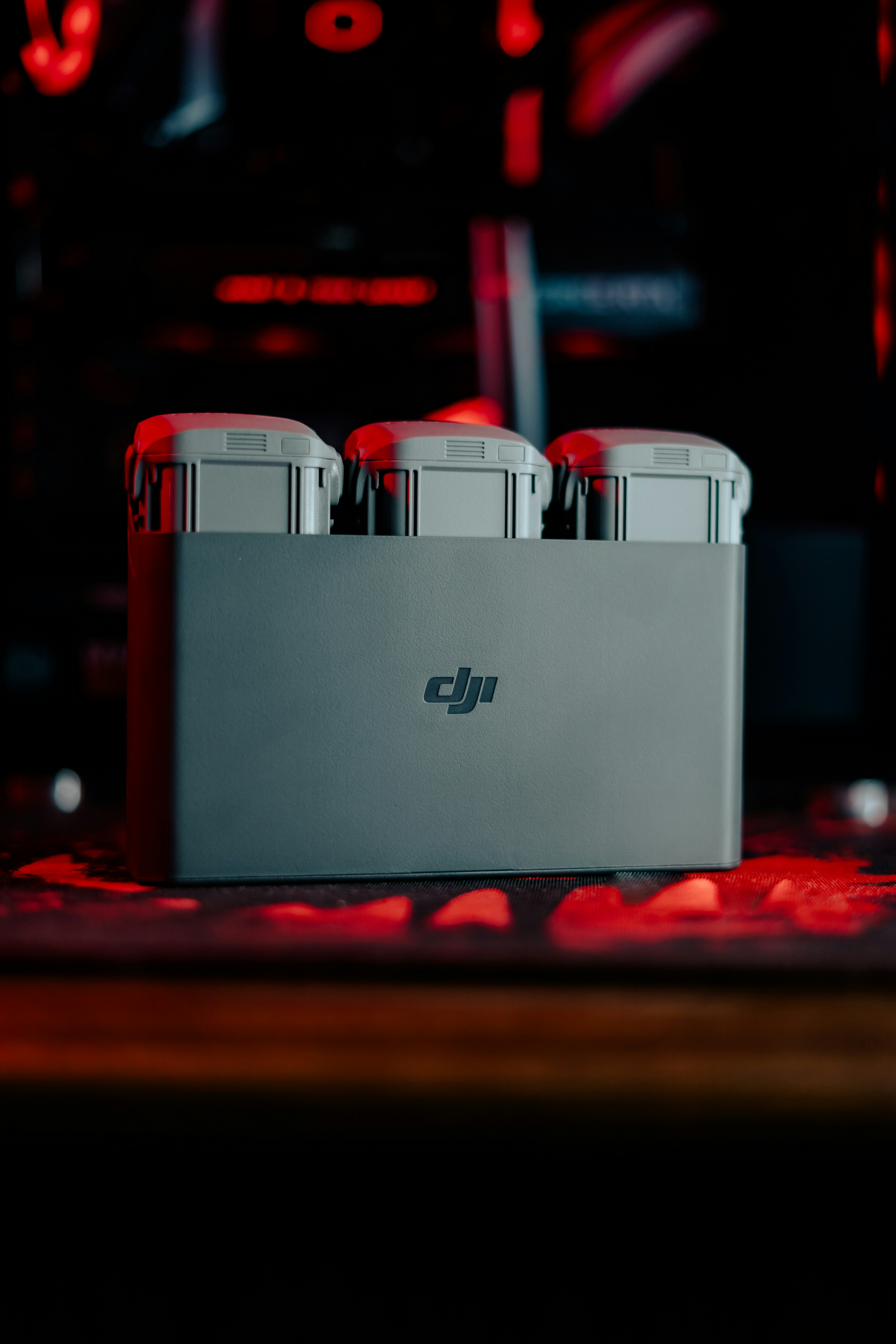 Crimson Neon Glow Illuminates a Trio of DJI Battery Caddies