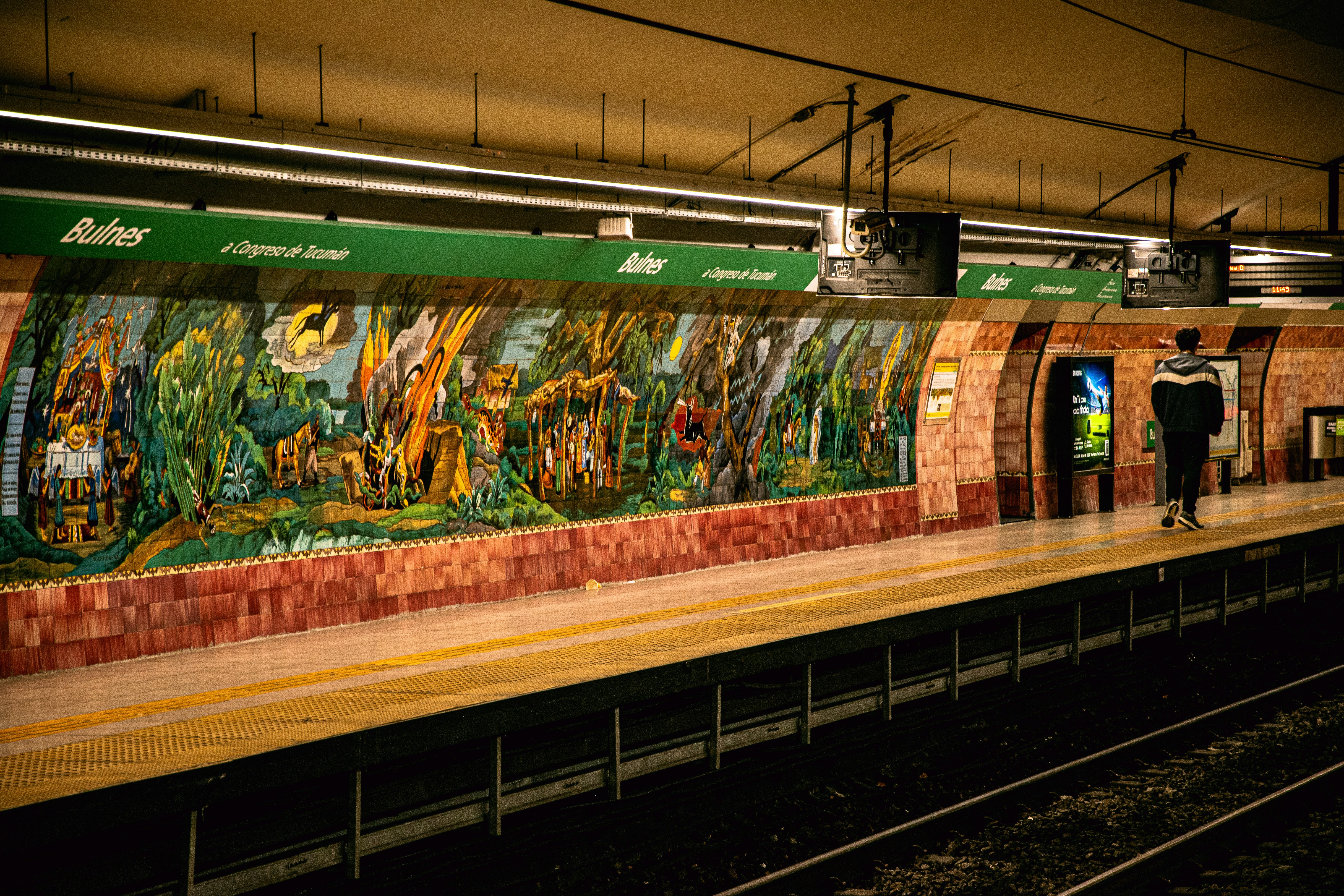 A subway station with a mural on the wall photo – Free Building Image ...