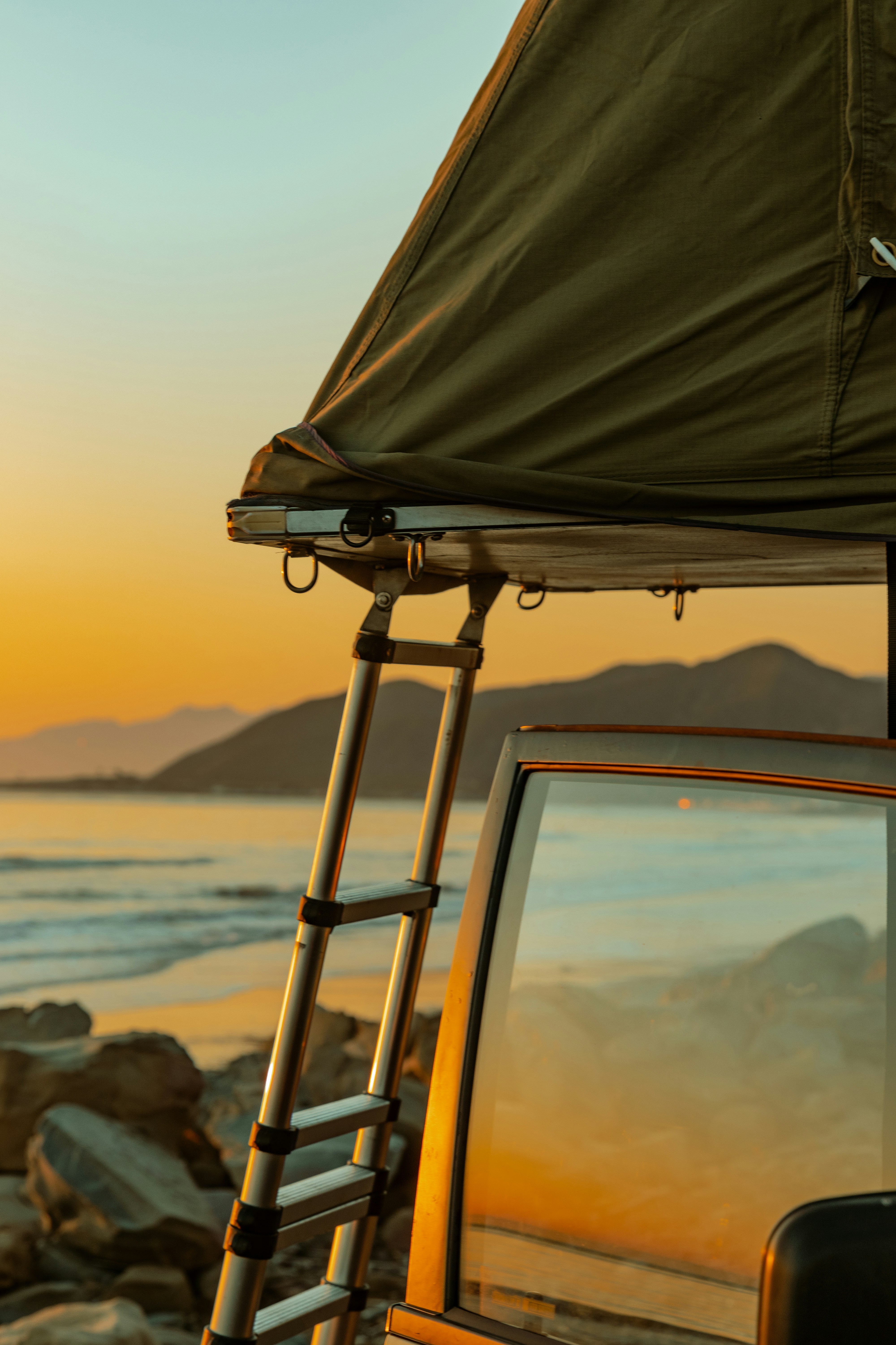 Dusk Rigging: Sunset Glow on a Tent-Topped Boat by the Shore