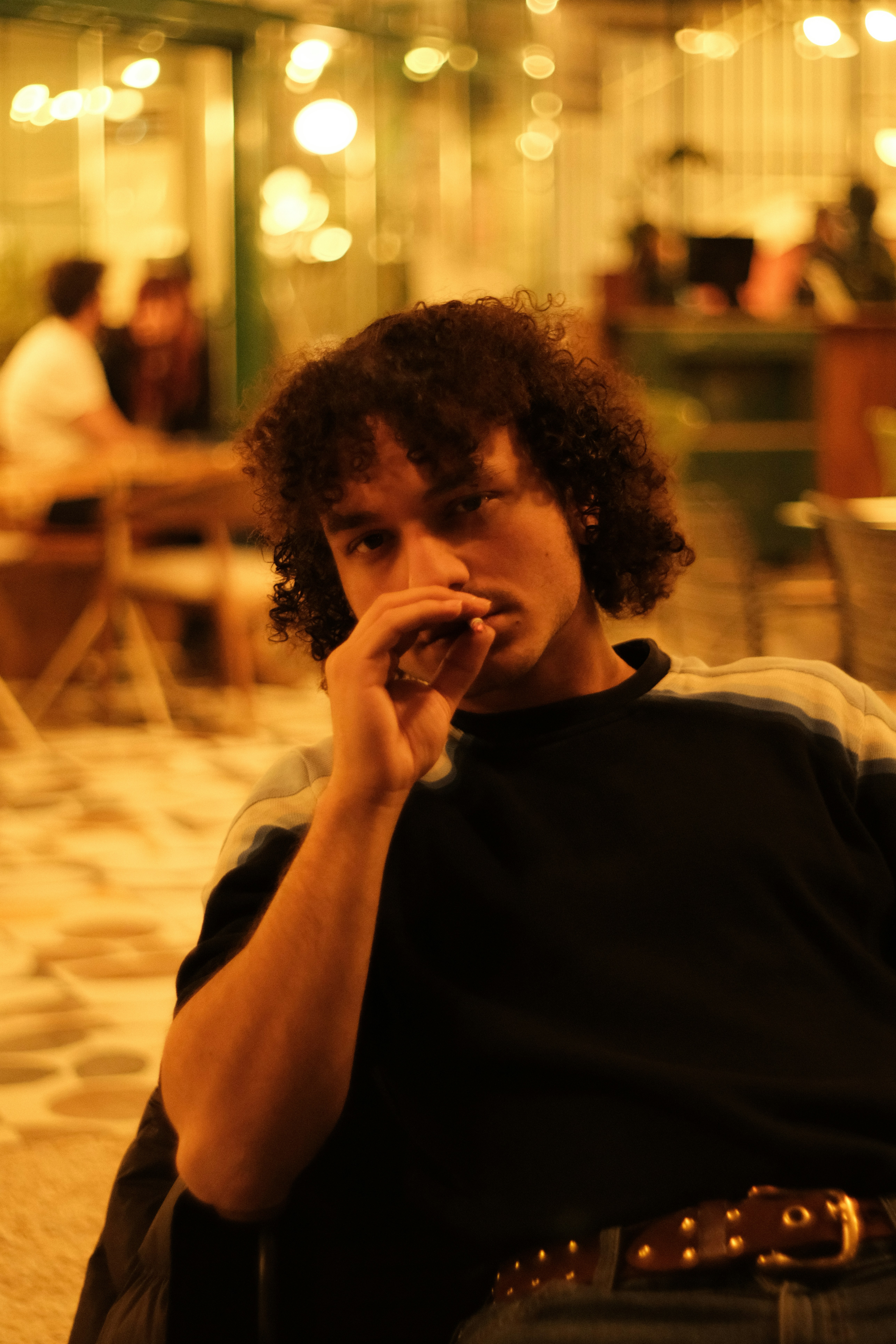 A man sitting on the ground eating food photo – Free Portrait Image on ...