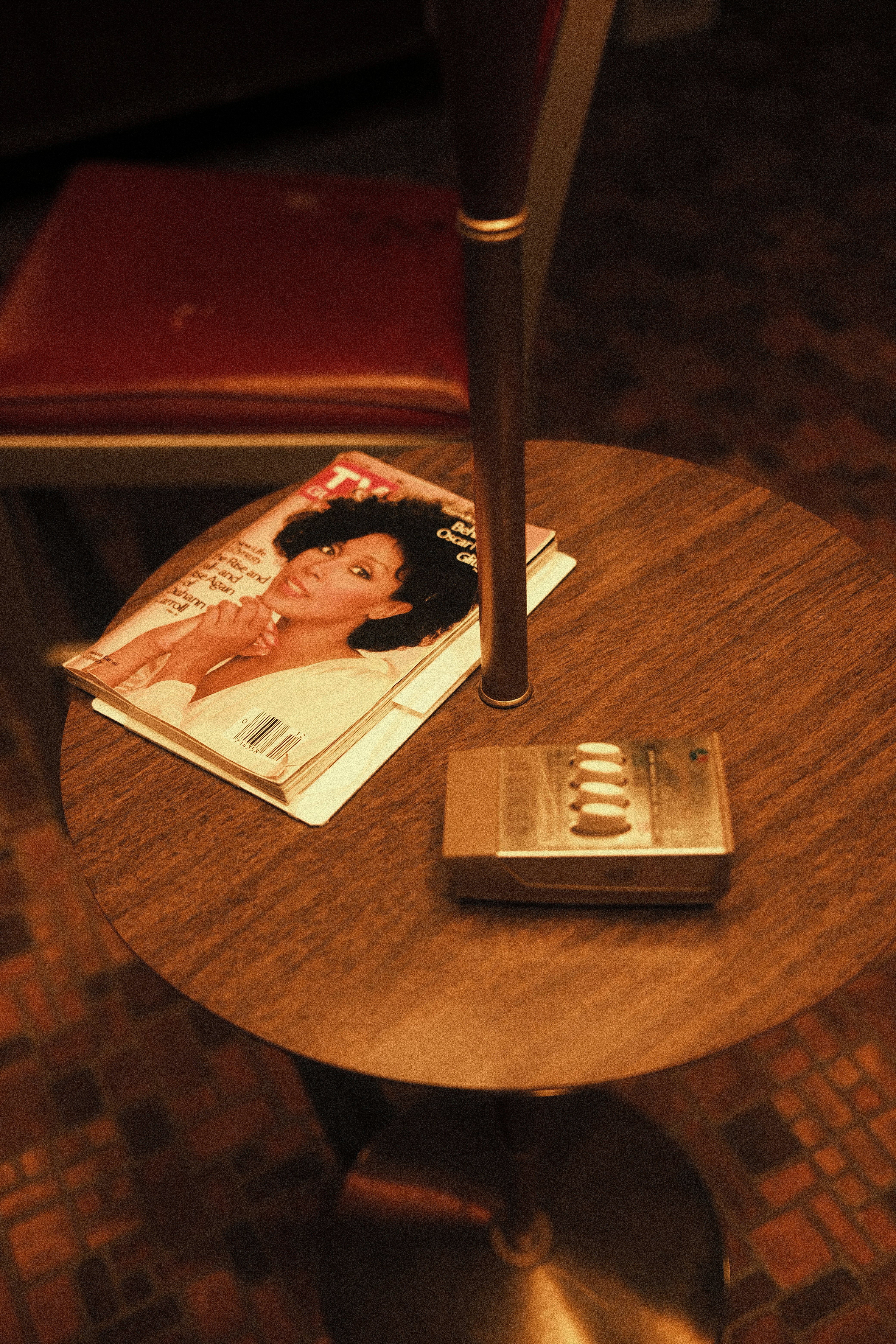 Amber Glow on a Round Table: A Quiet Still-Life with a Magazine and Box