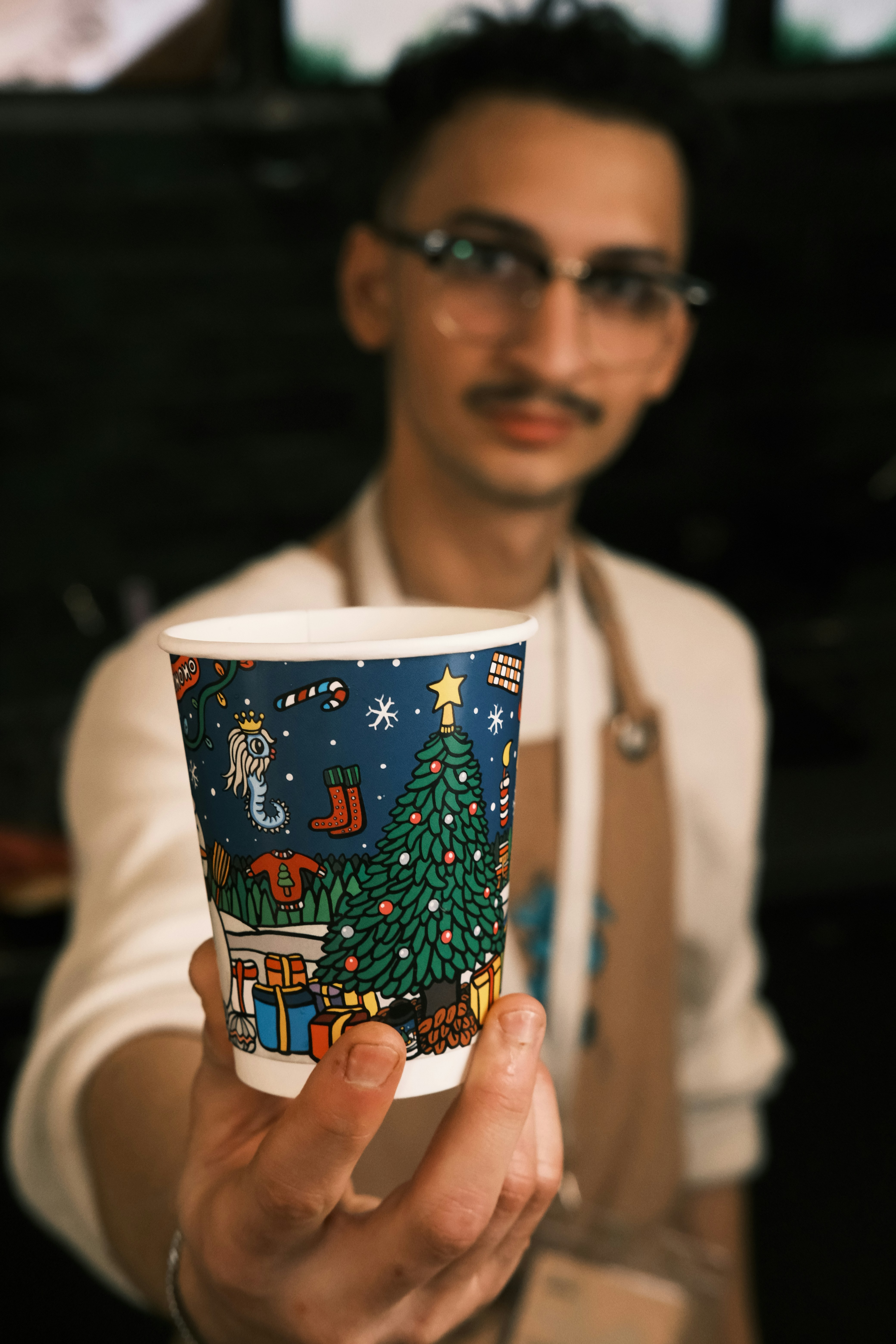 Clutch of Christmas Color: A Festive Cup Reaches Toward the Lens