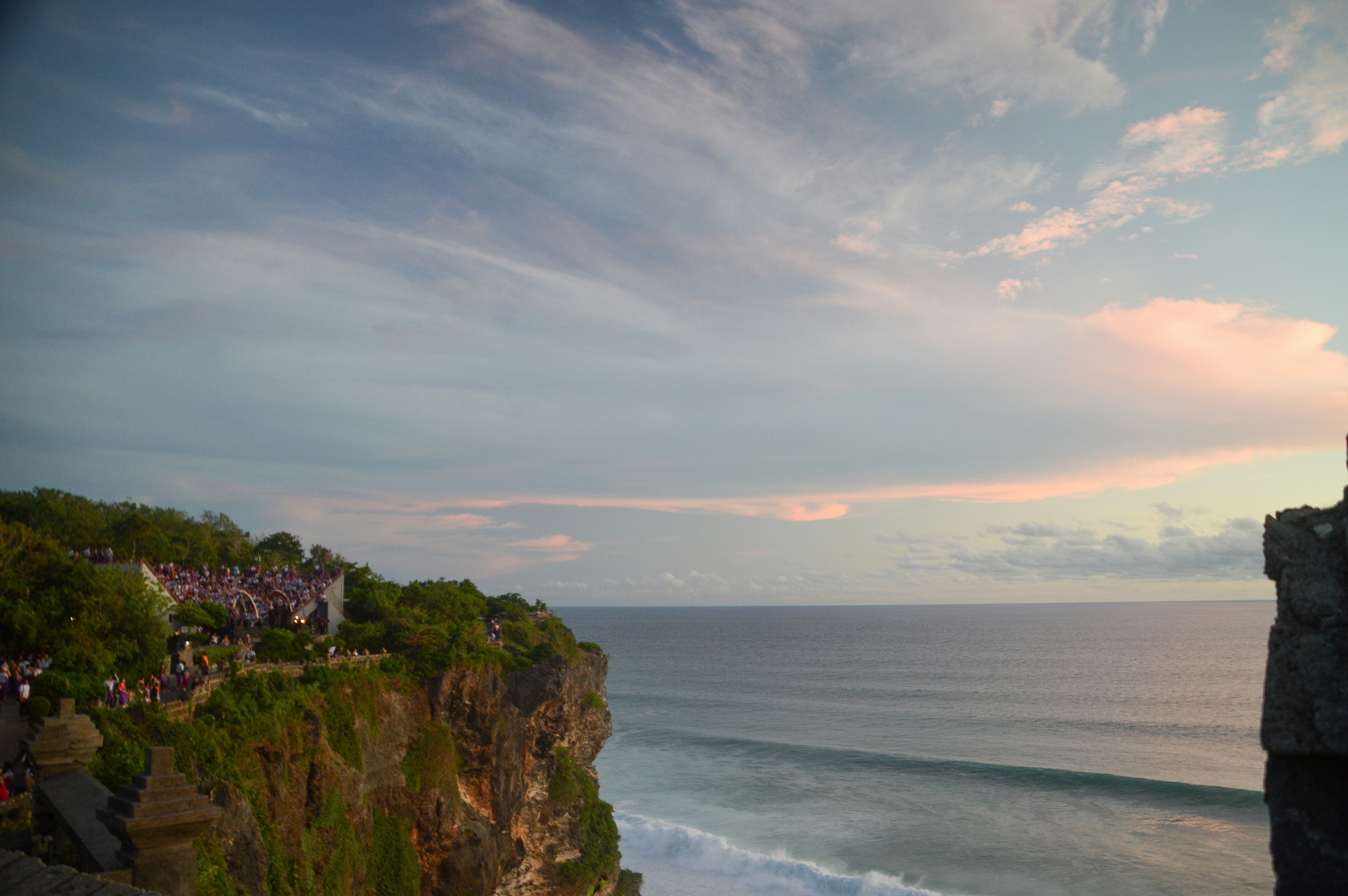 Pastel Skies Over a Cliffside Crowd at Sunset