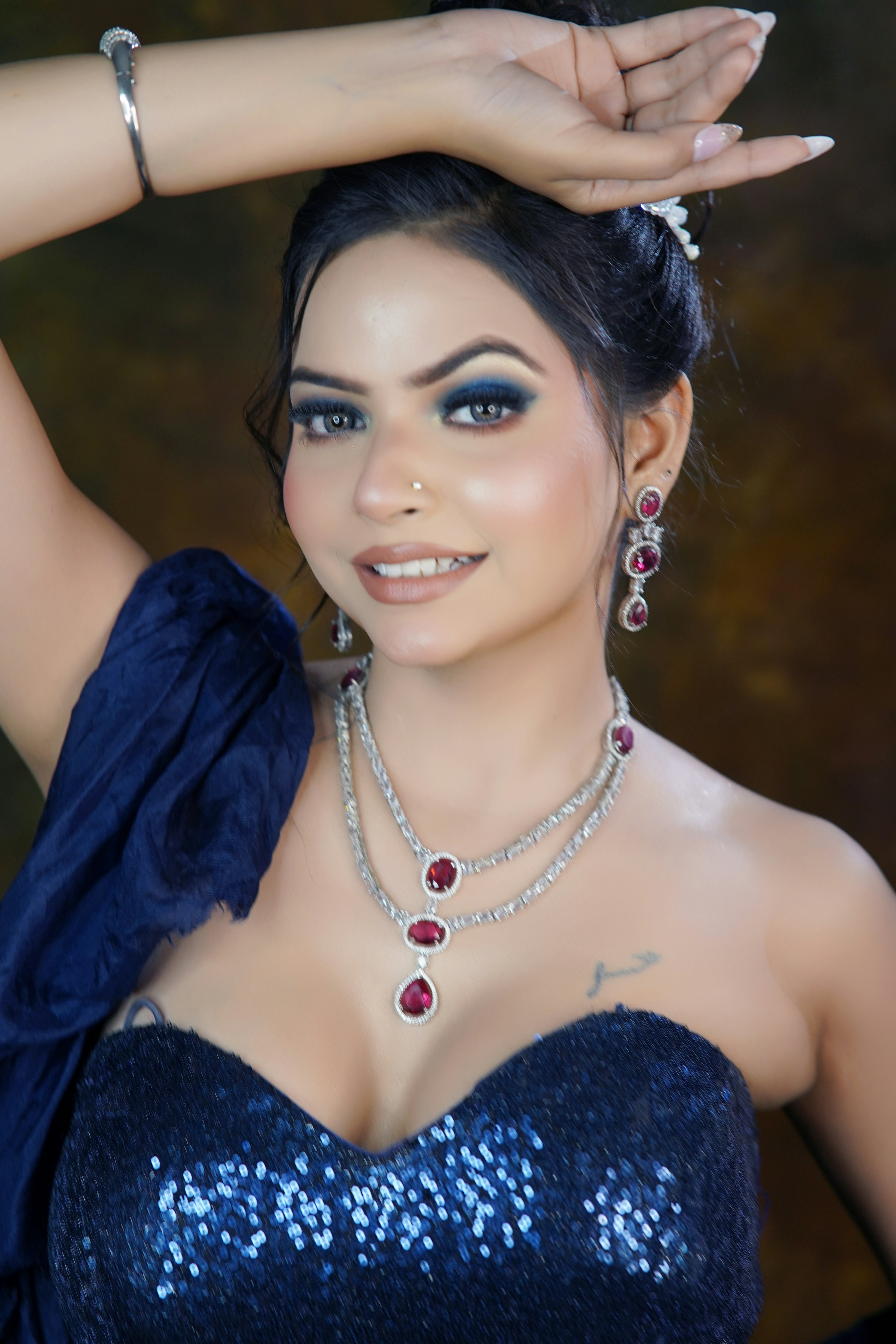 A woman in a blue dress posing for a picture photo – Free Face Image on ...