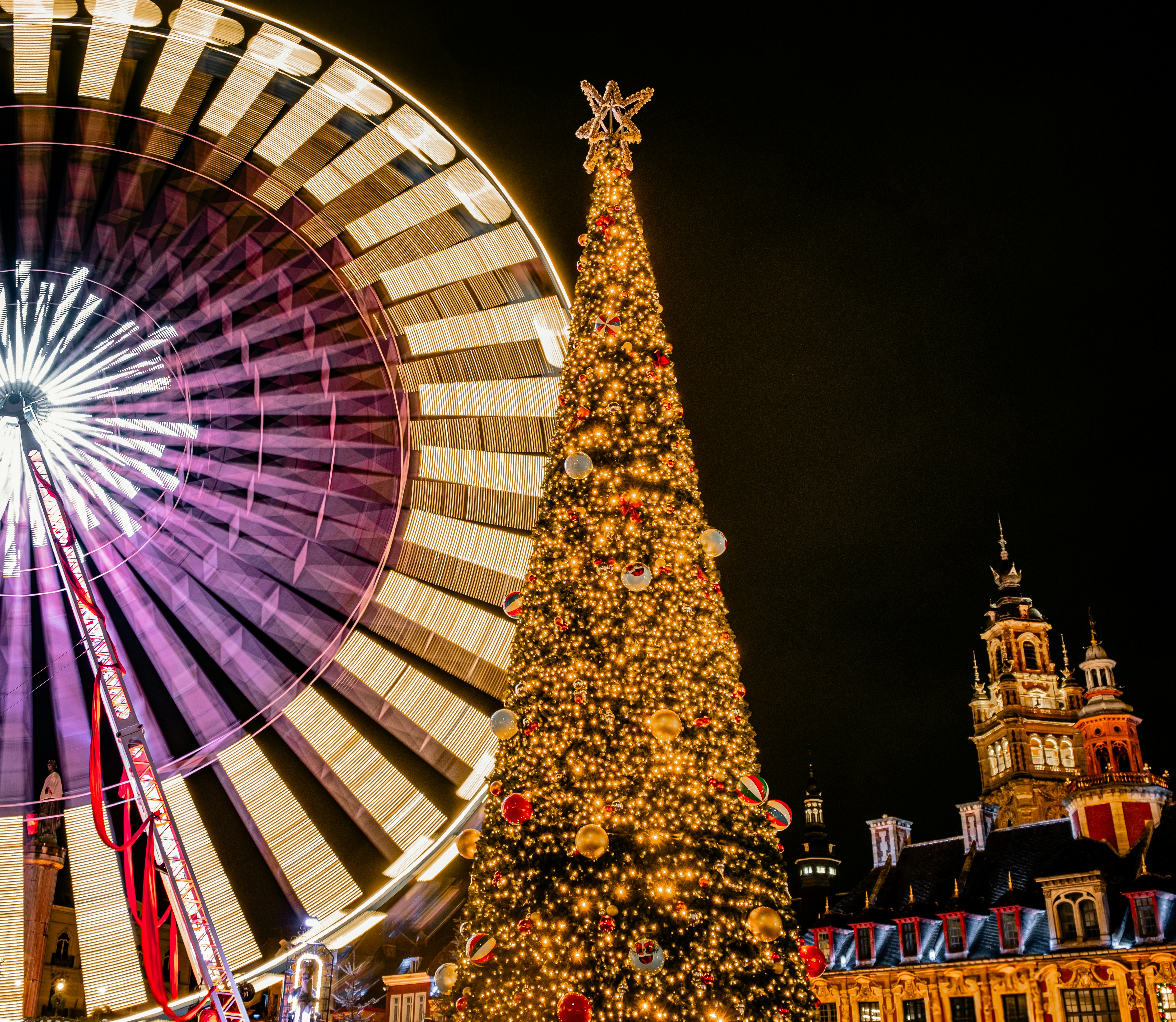 Ornamented Night: Christmas Tree Anchors a Luminous Ferris Wheel