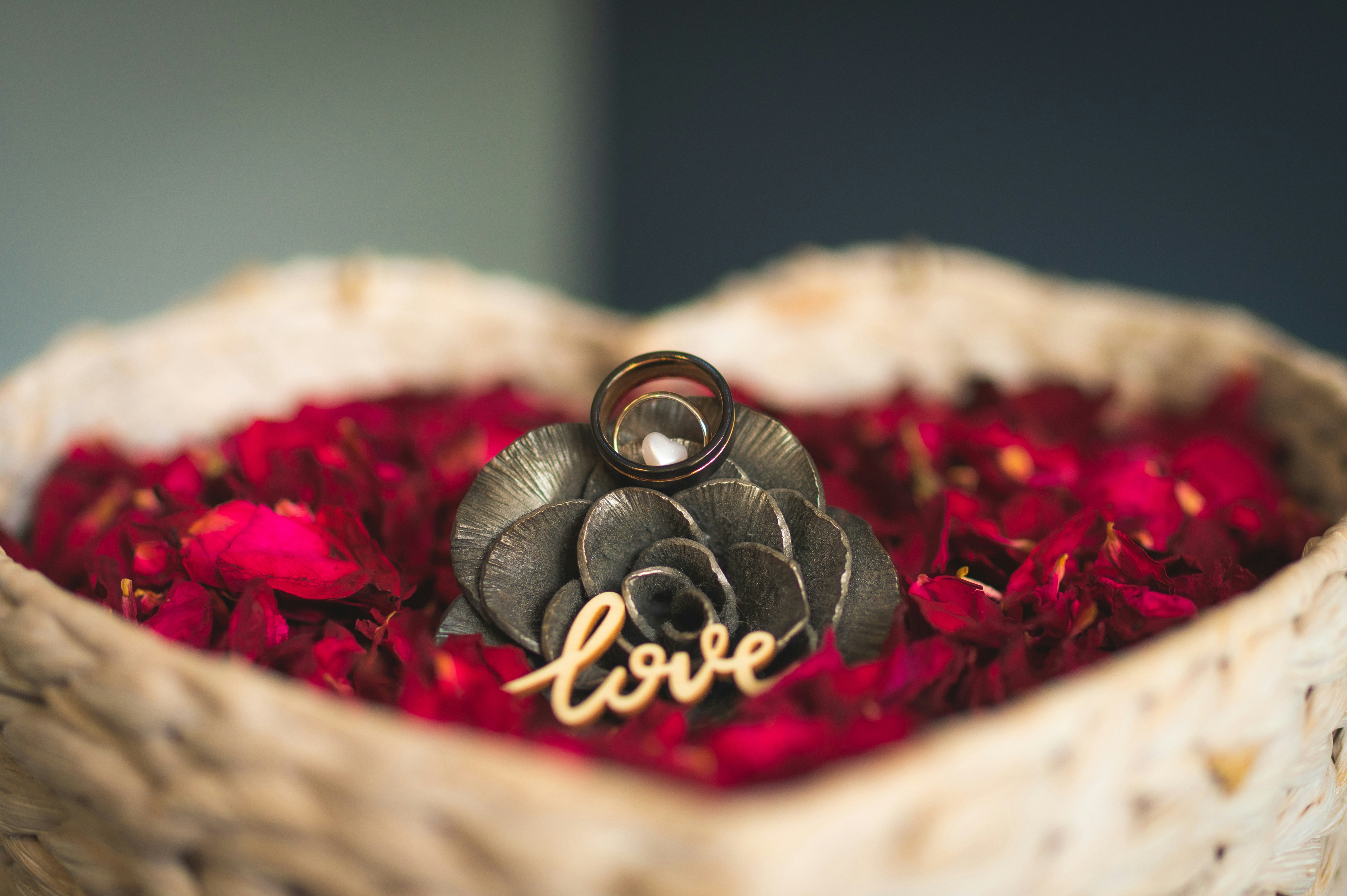 Love in Focus: A Ring and Roses Nestled in a Woven Heart