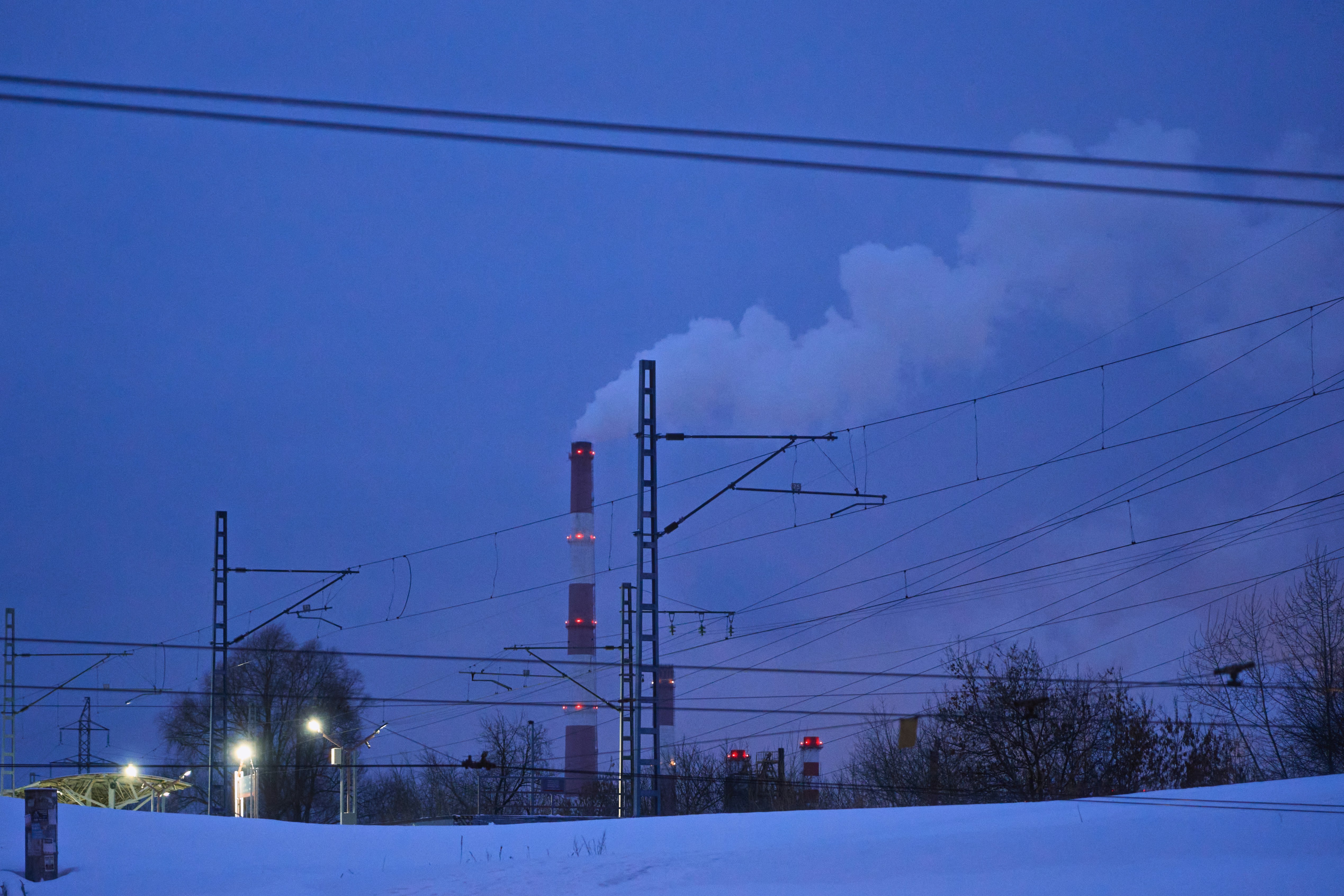Blue Hour Tracks: Snow, Wires, and a Stalwart Smokestack