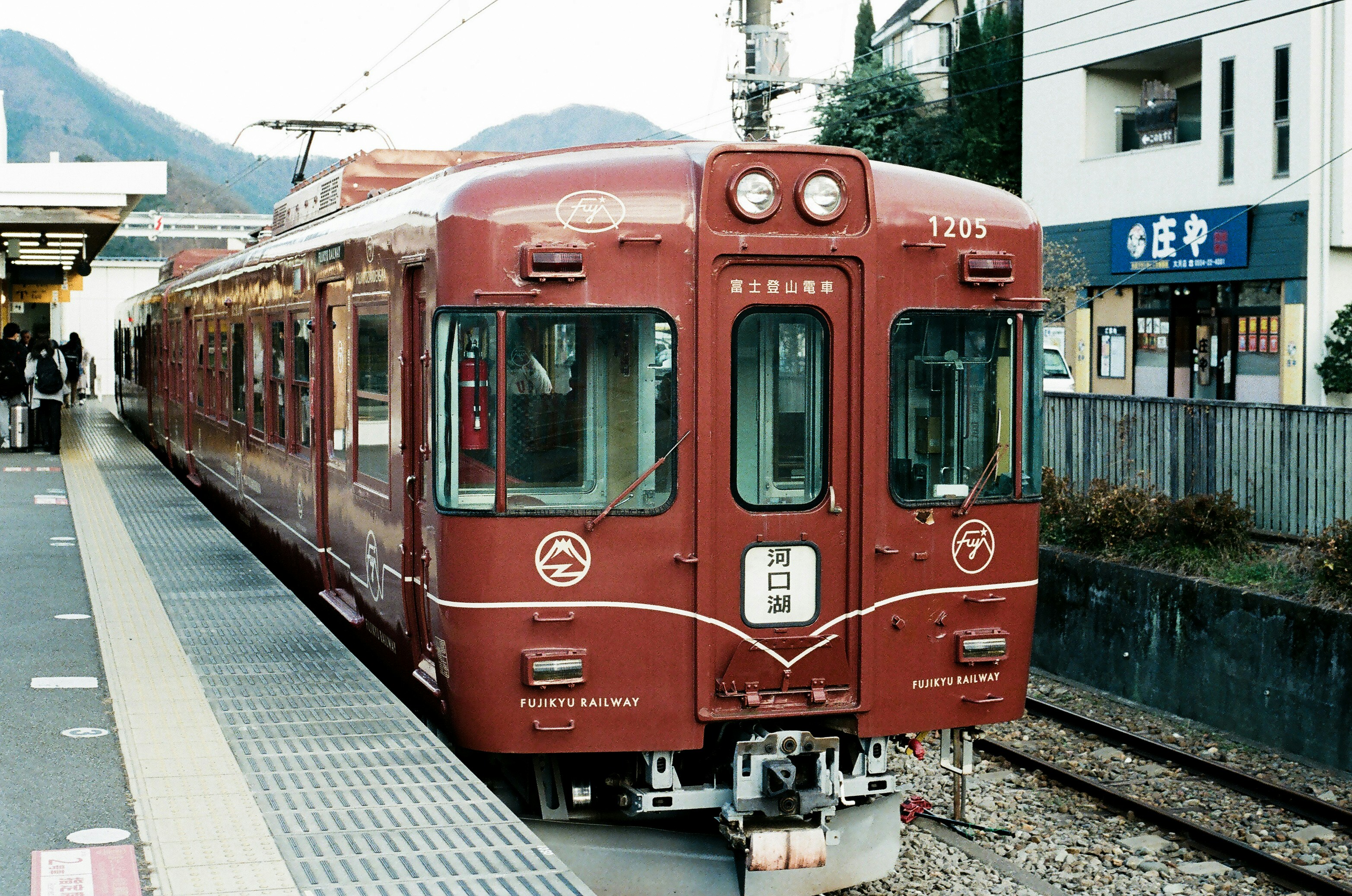 A red train pulling into a train station photo – Free Car Image on Unsplash
