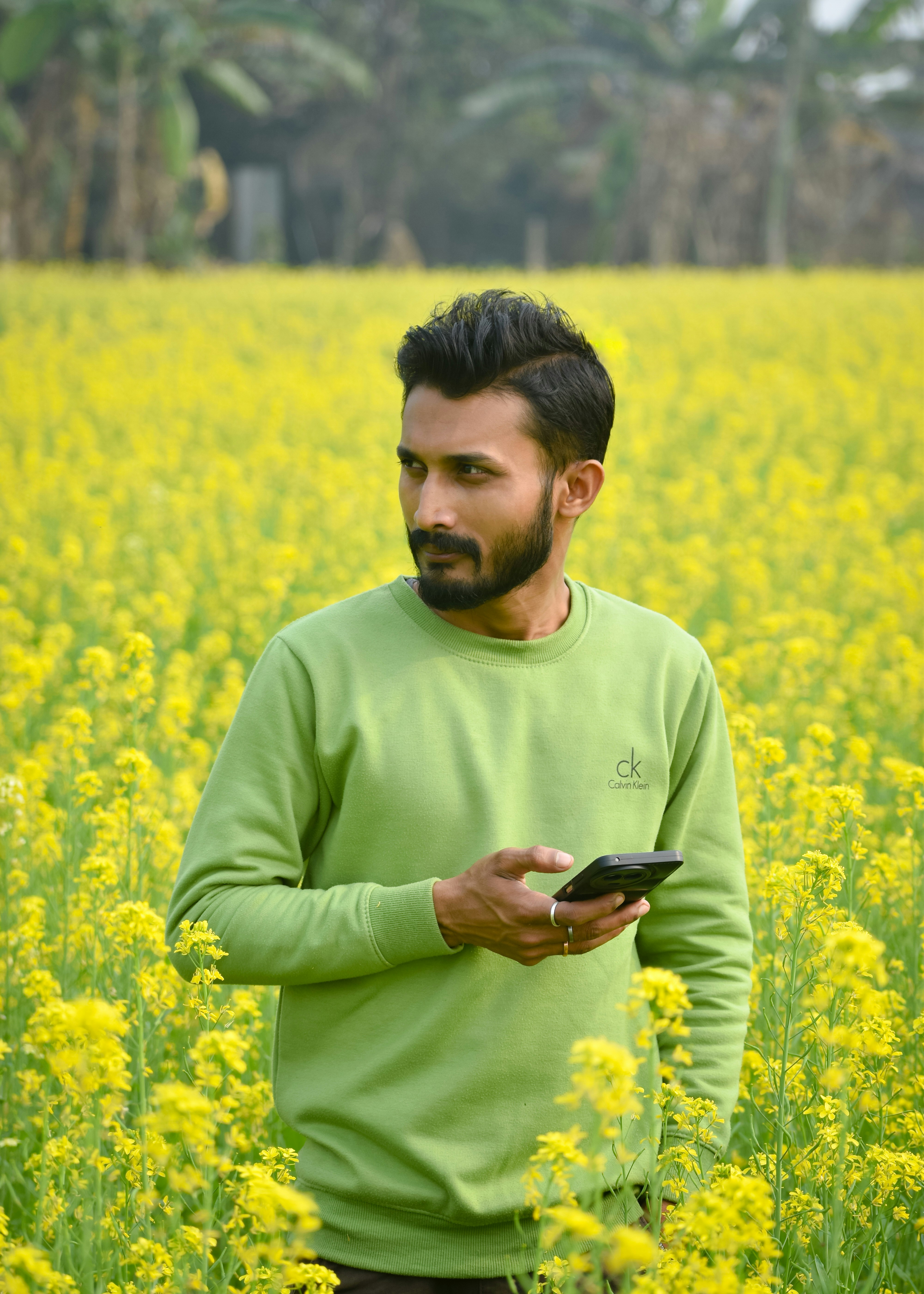 Verdant Canola Portrait: A Green-Sweater Moment in a Sea of Yellow