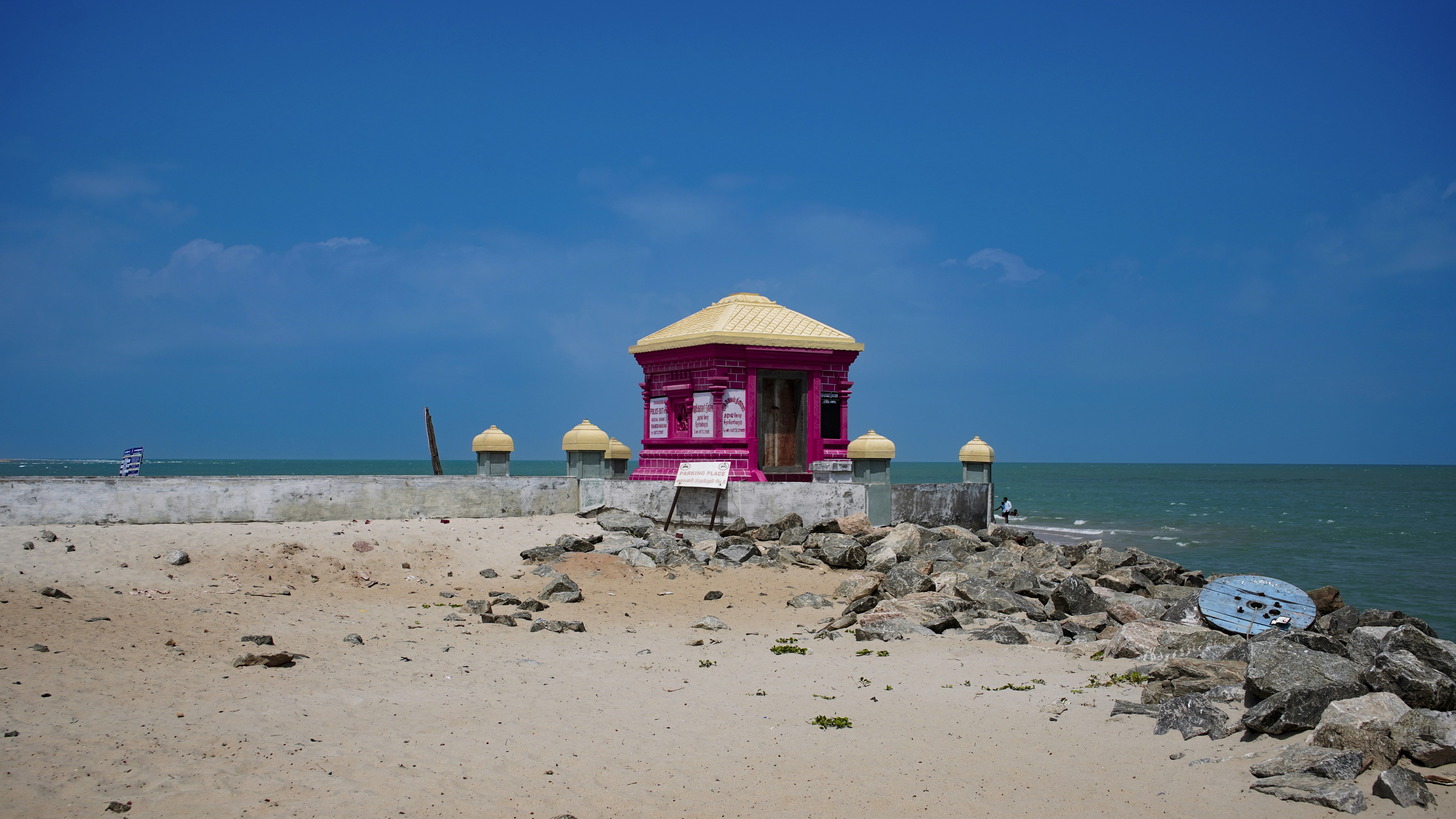 A red and yellow hut sitting on top of a sandy beach photo – Free ...