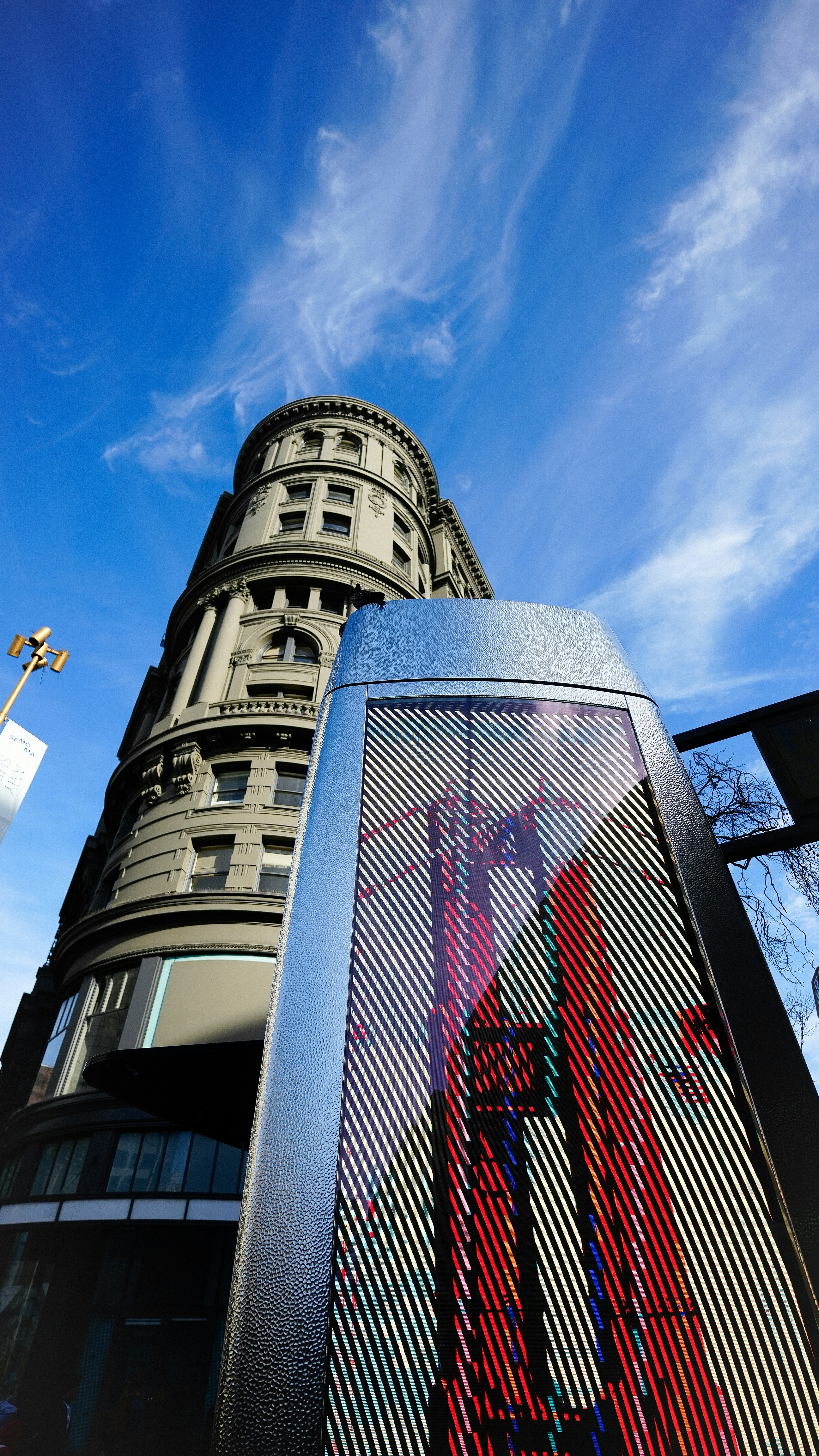 Rotunda Rising: Historic Tower Framed by Striped Public Art Panel