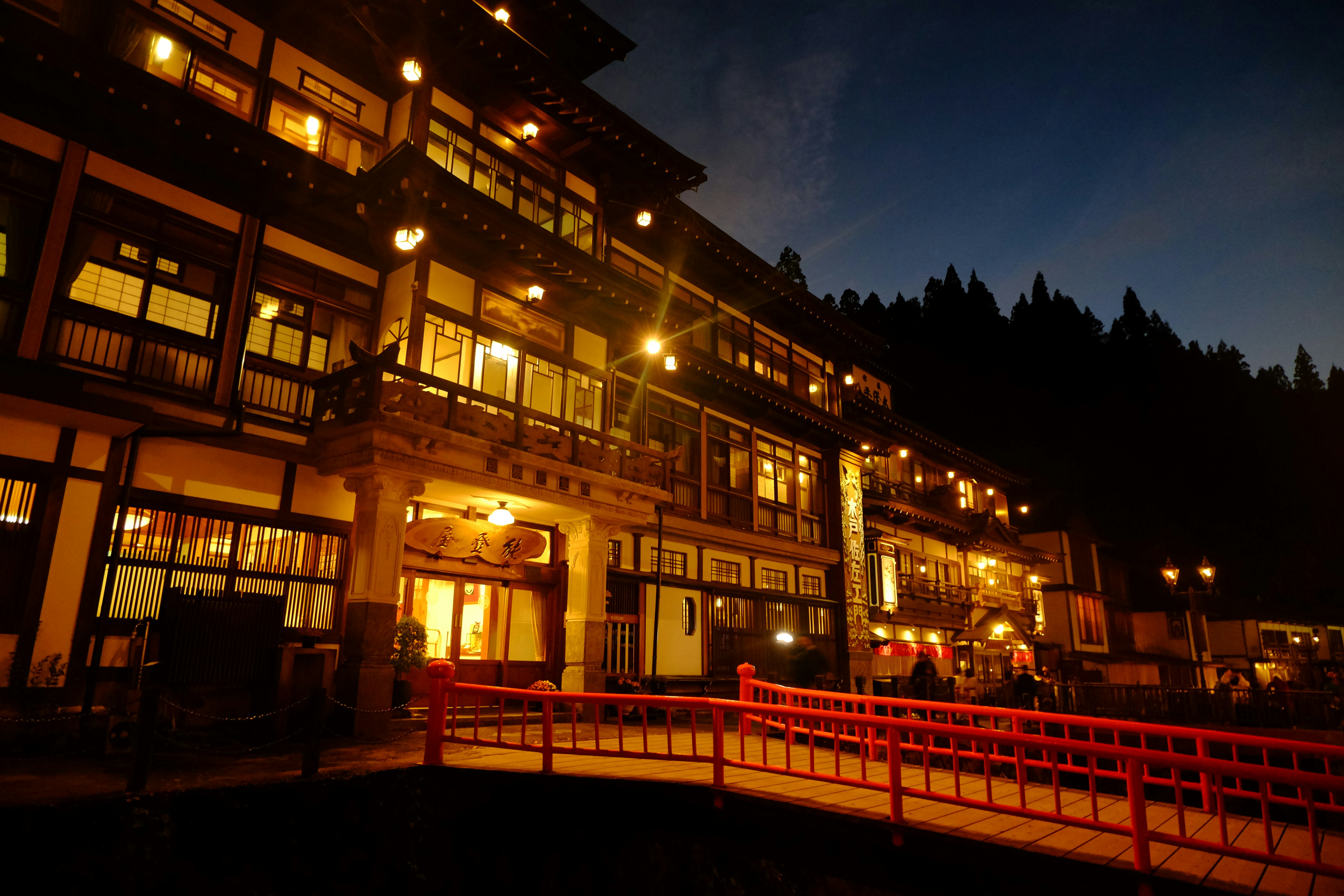 A large building lit up at night with lights on photo – Free Ginzan ...