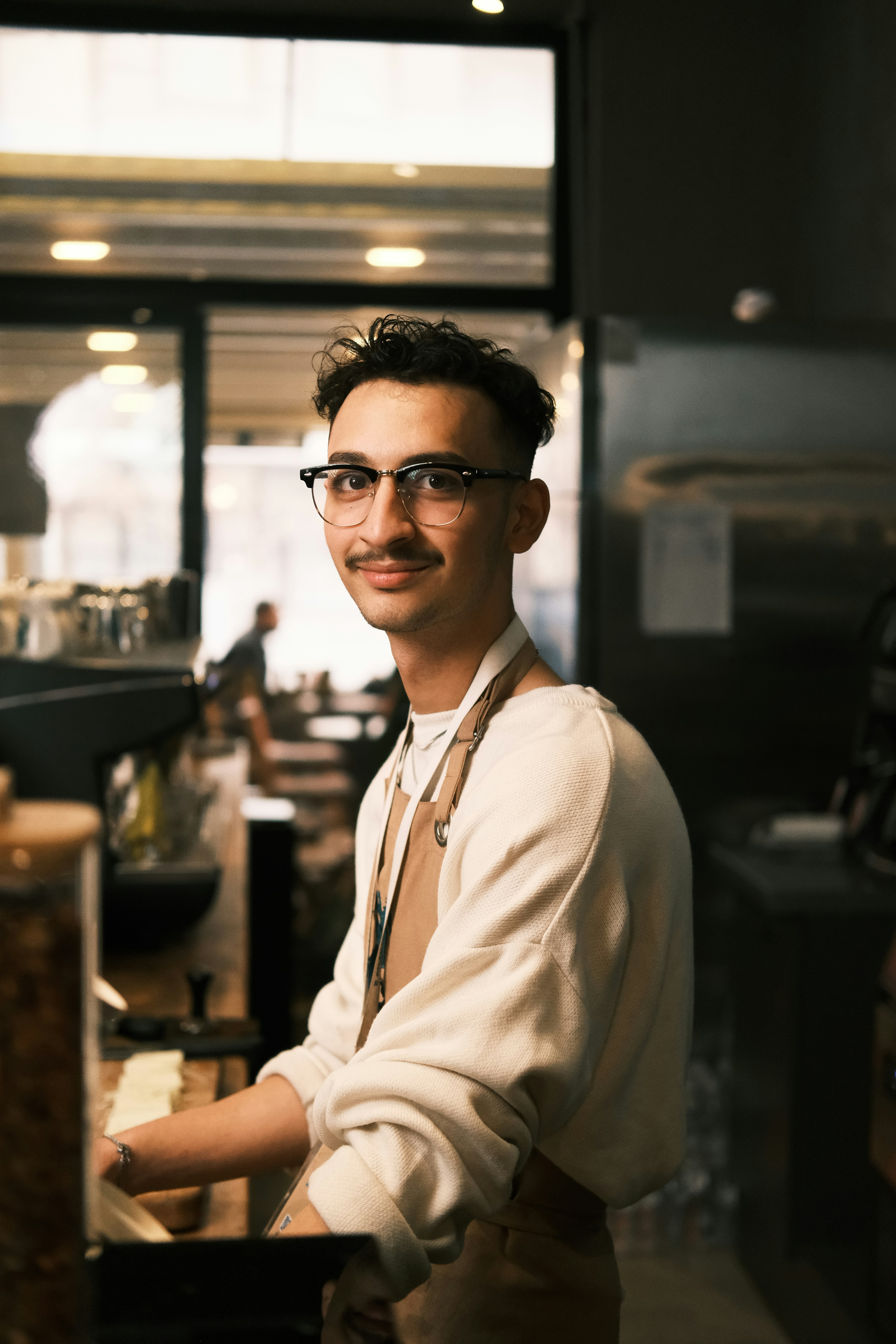 A man standing in front of a counter in a restaurant photo – Free ...