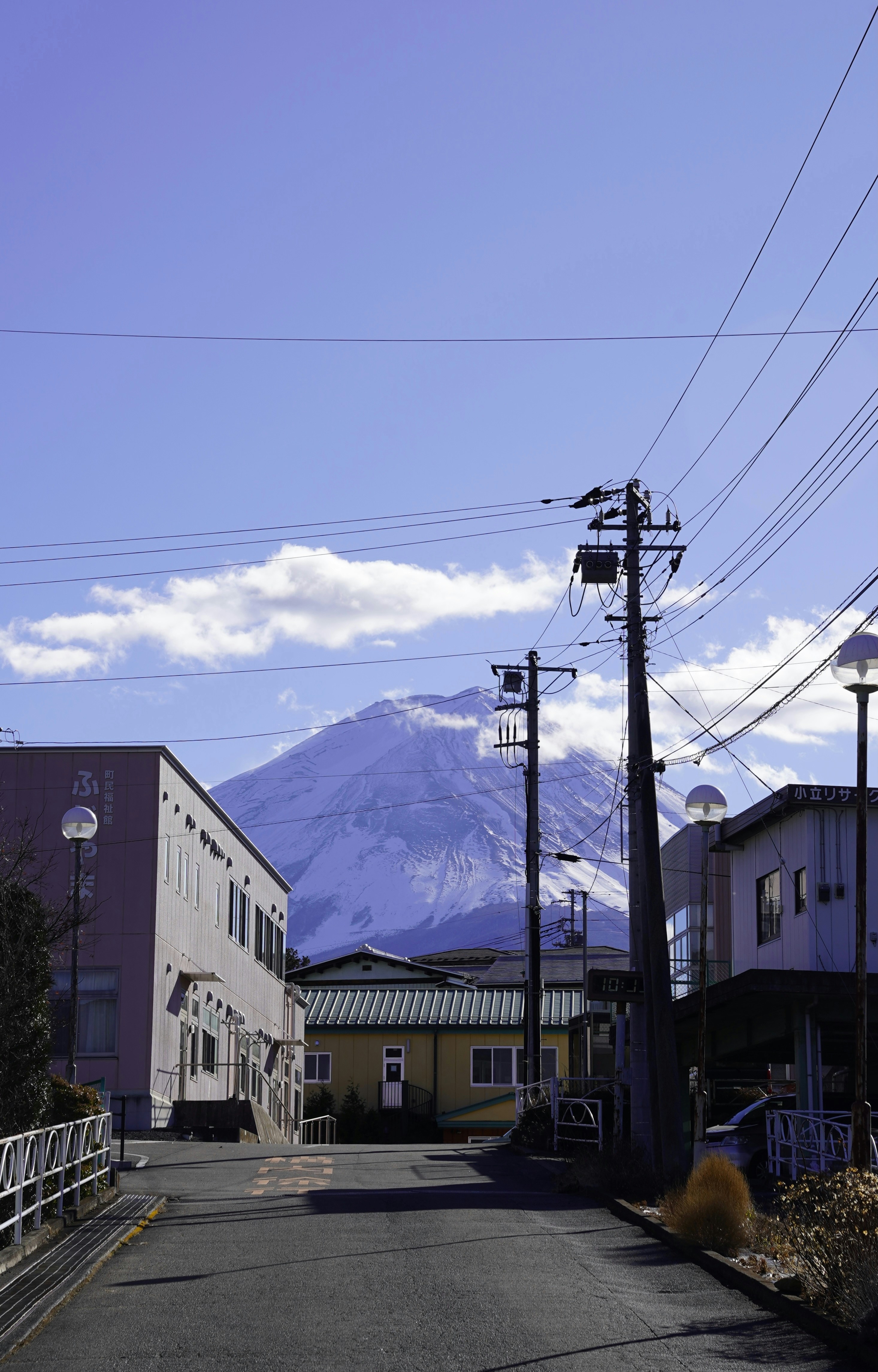 Snow-Capped Peak Over a Quiet Coastal Street