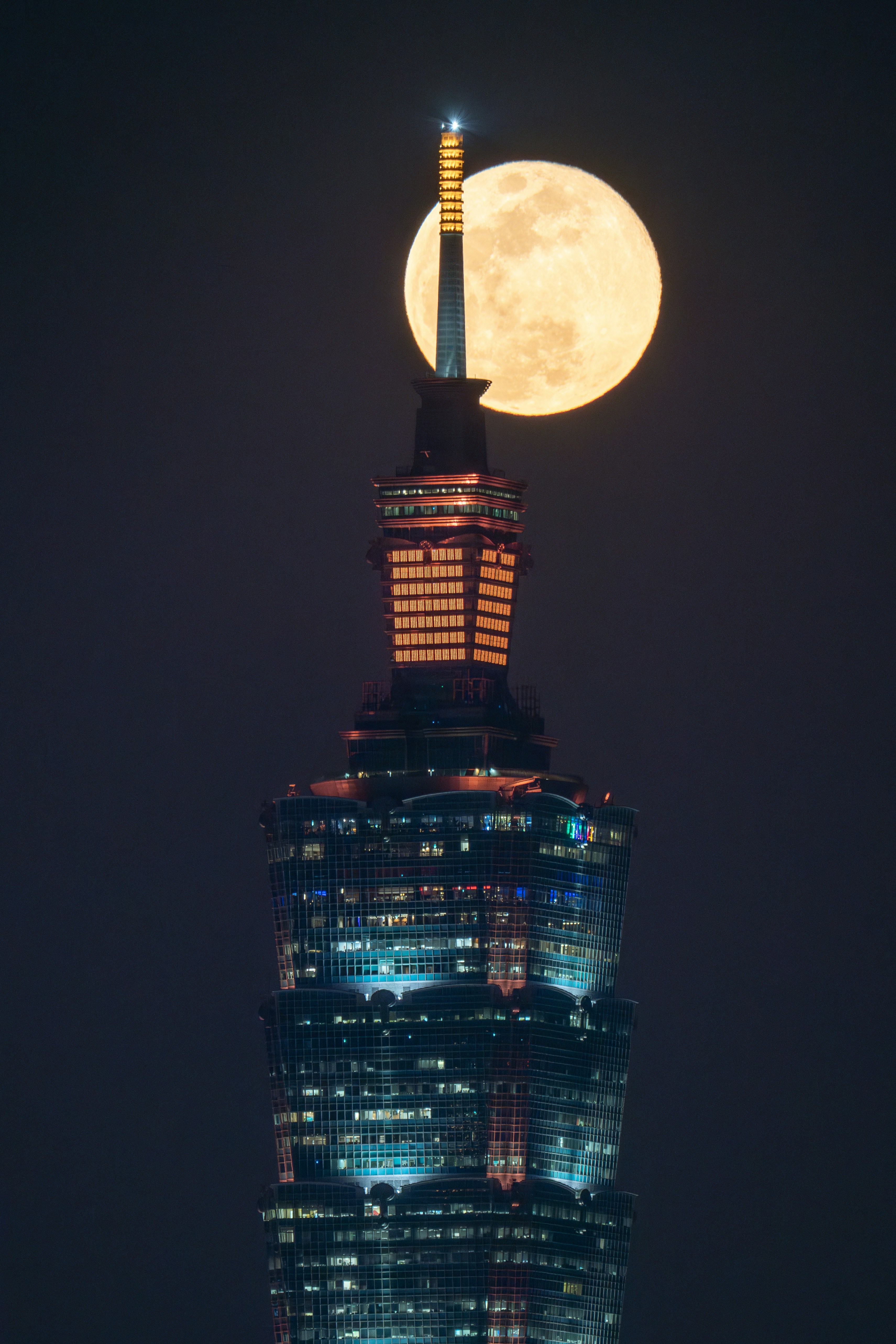 A very tall building with a full moon in the background photo – Free ...