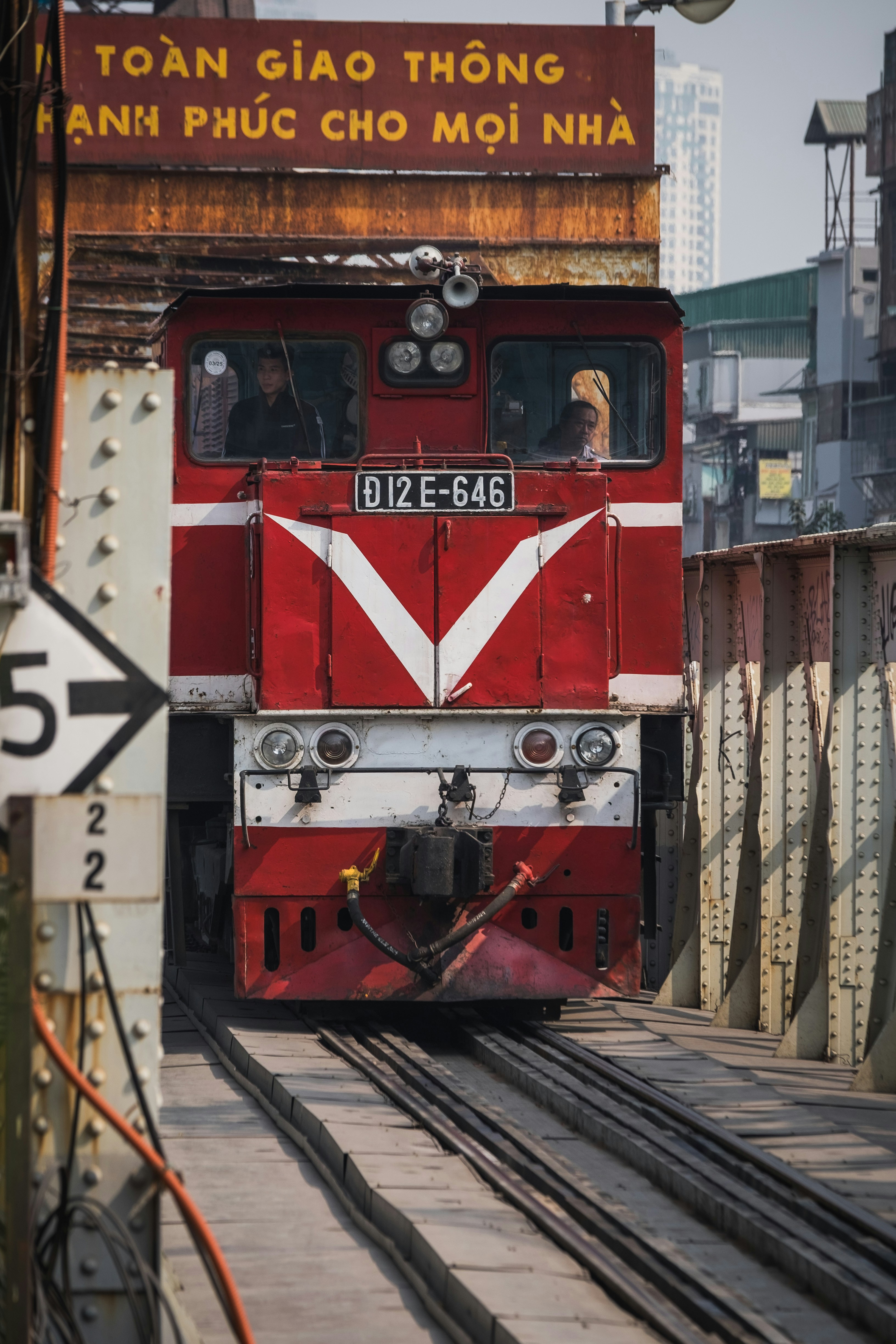 Red Locomotive Emergence: Bricks, Rails, and a City Light