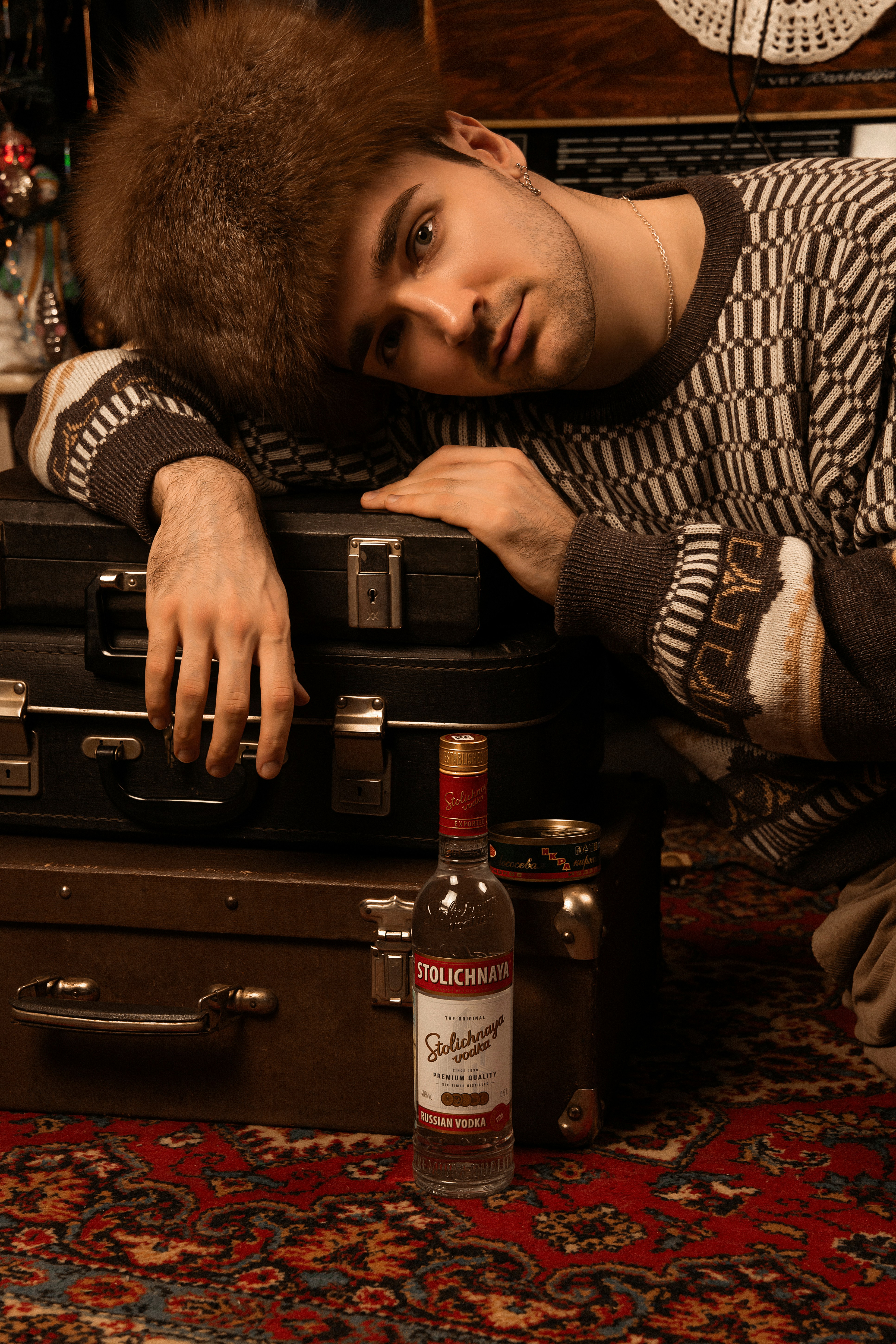 A man laying on top of a pile of luggage photo – Free Portrait Image on ...