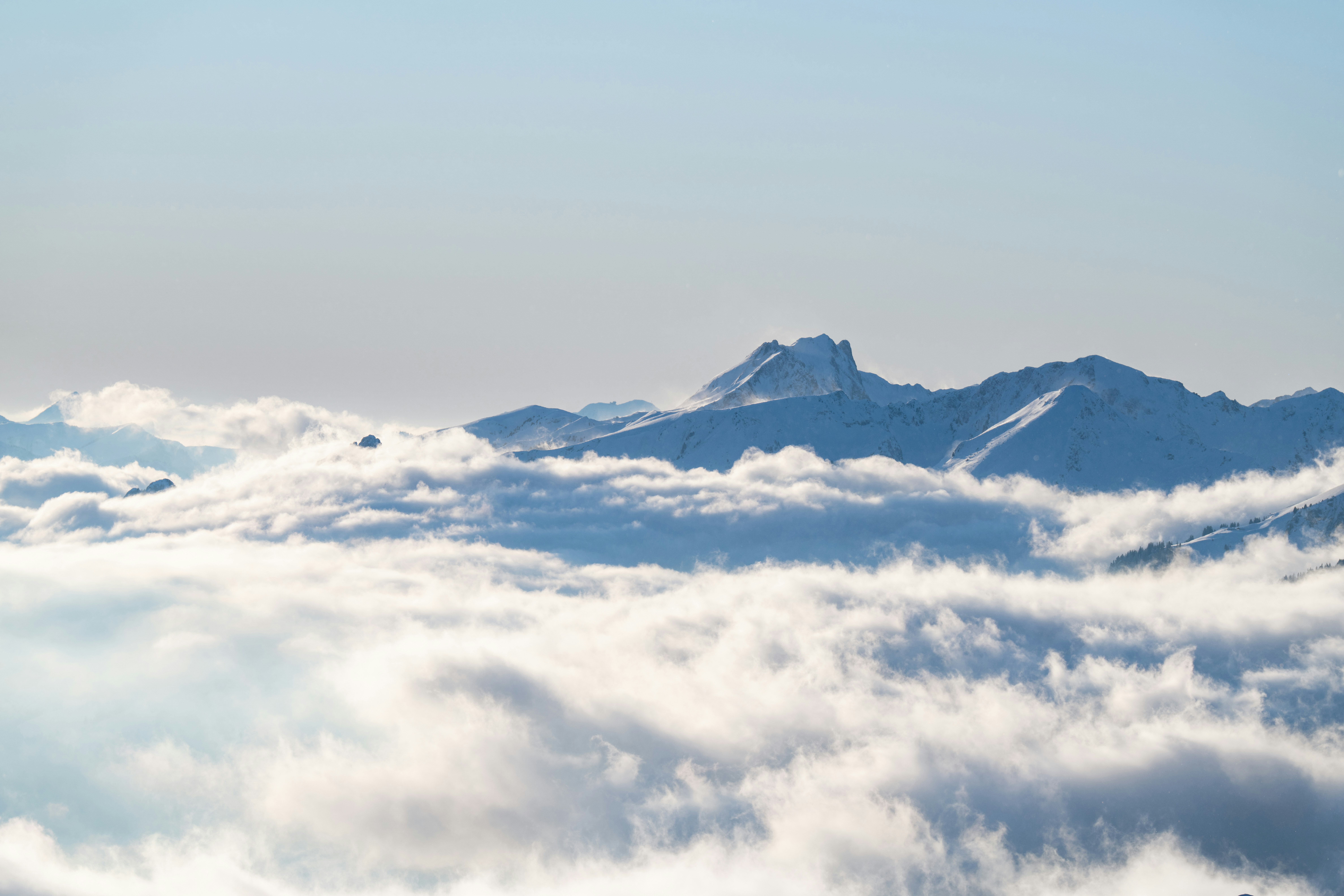 A group of mountains in the distance with clouds in the foreground ...