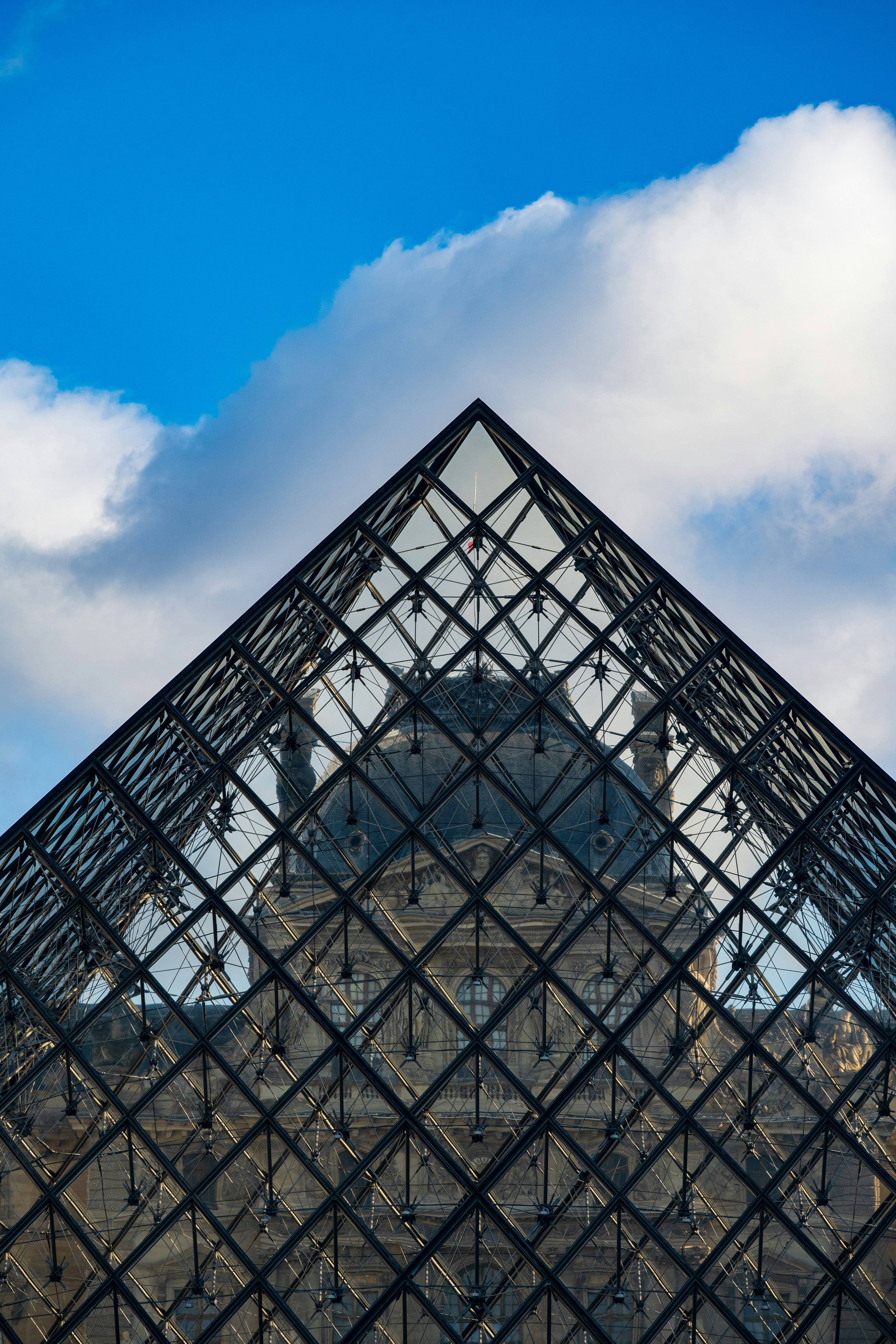 Pyramid Facade: Reflections and Structural Geometry Over the Louvre
