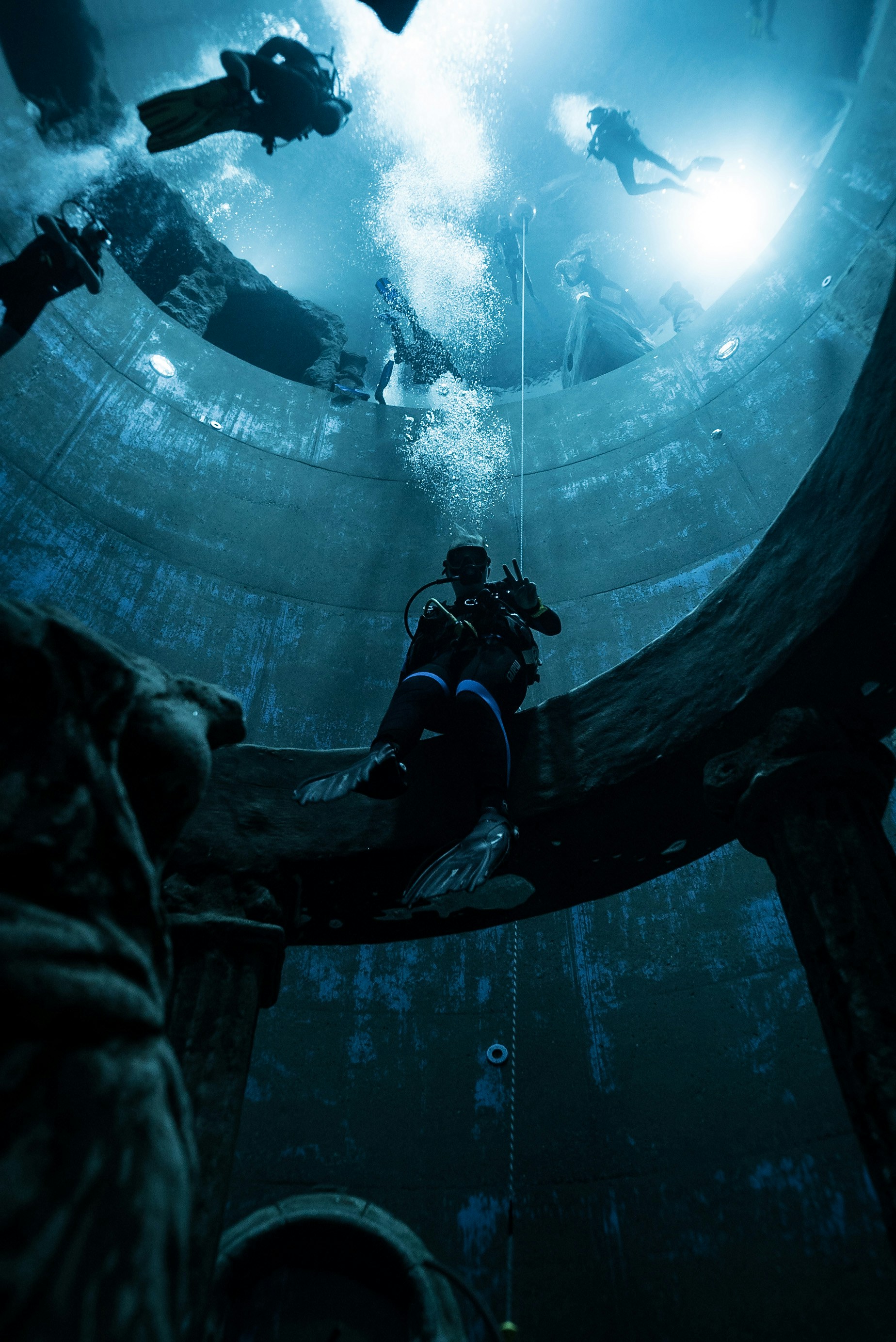A group of scubas in a large underwater tunnel photo – Free Sport Image ...