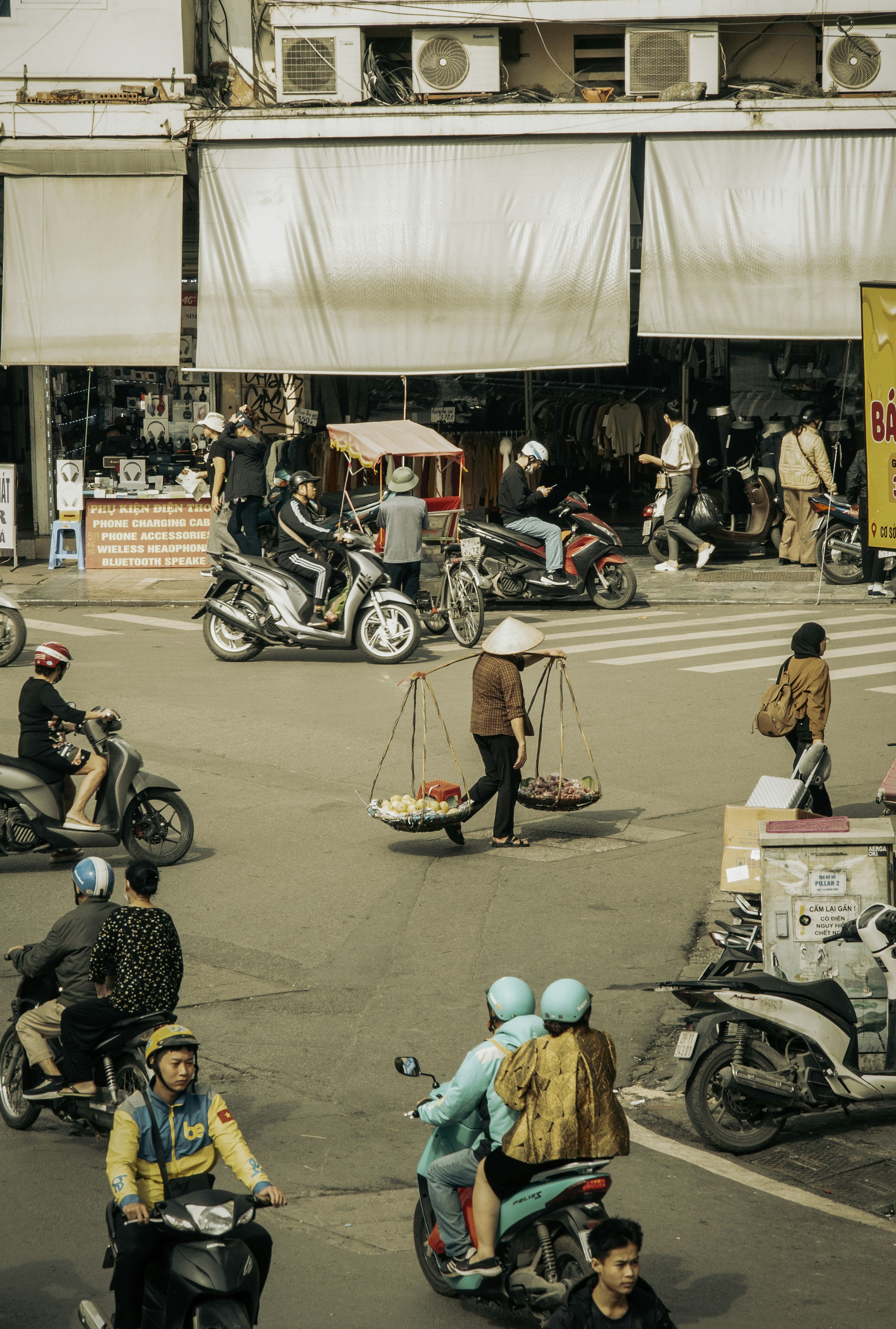 A group of people riding scooters down a street photo – Free Travel ...