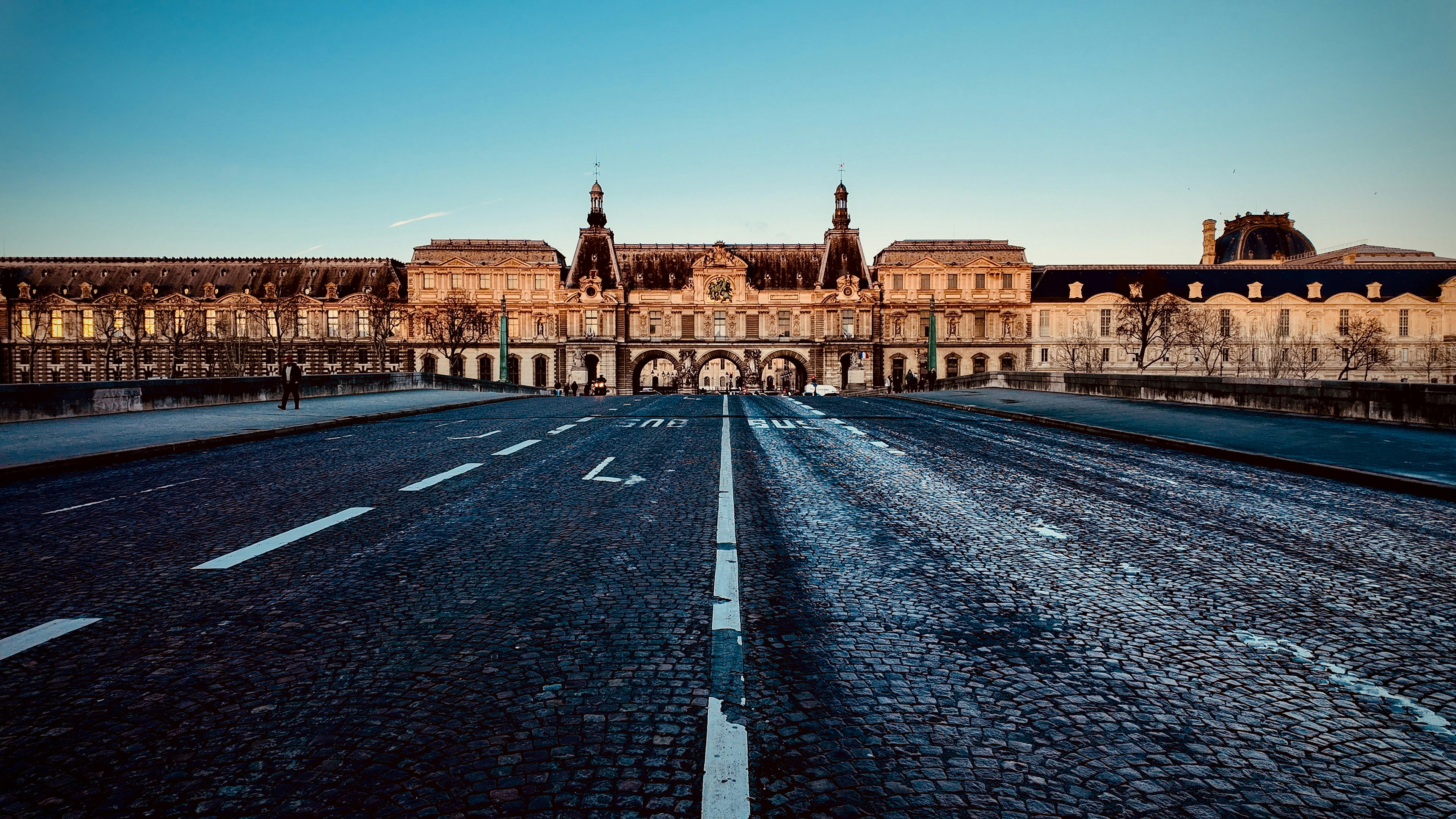 An empty street in front of a large building