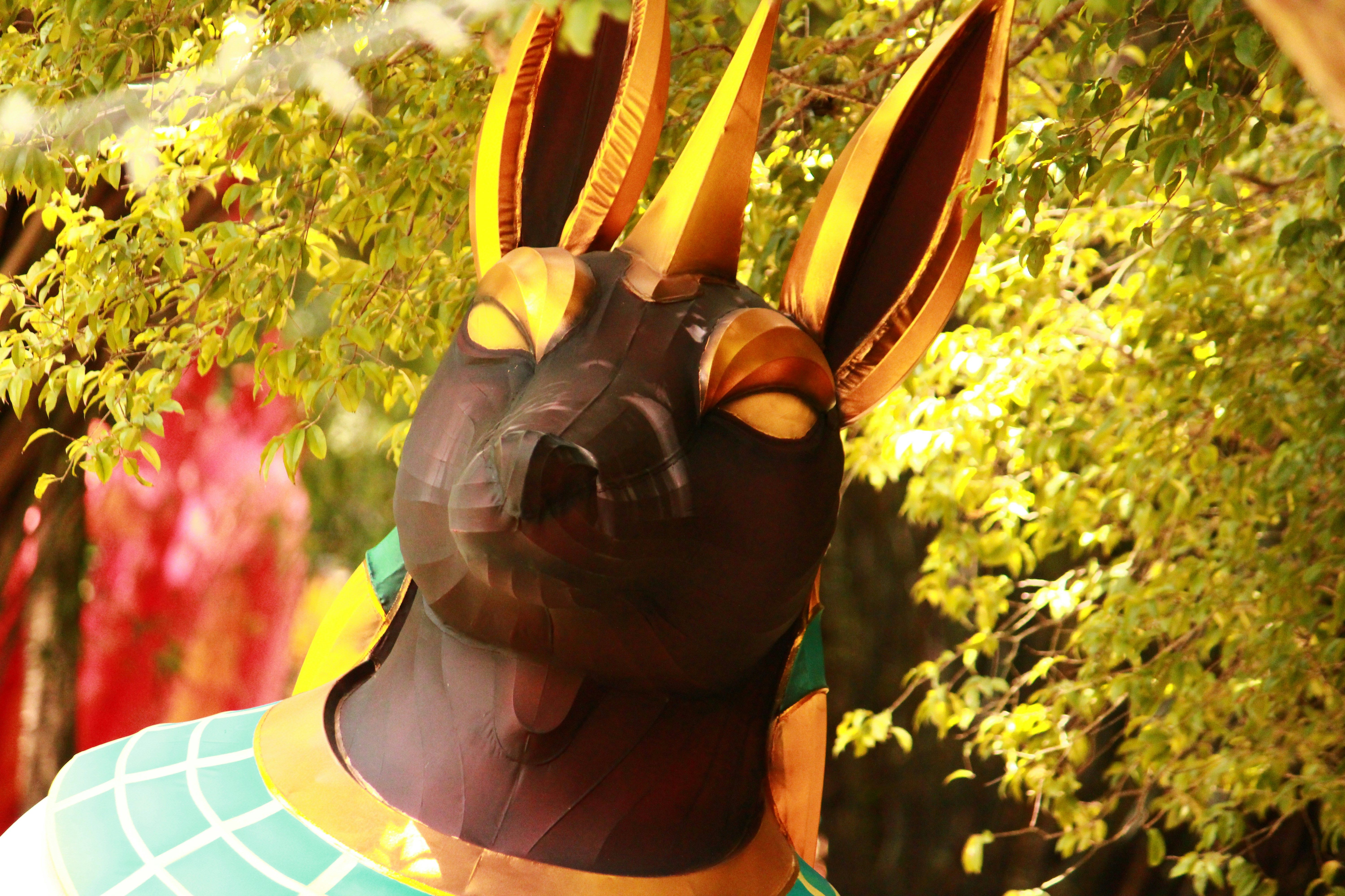Sunlit Bunny Mask Among Verdant Carnival Foliage