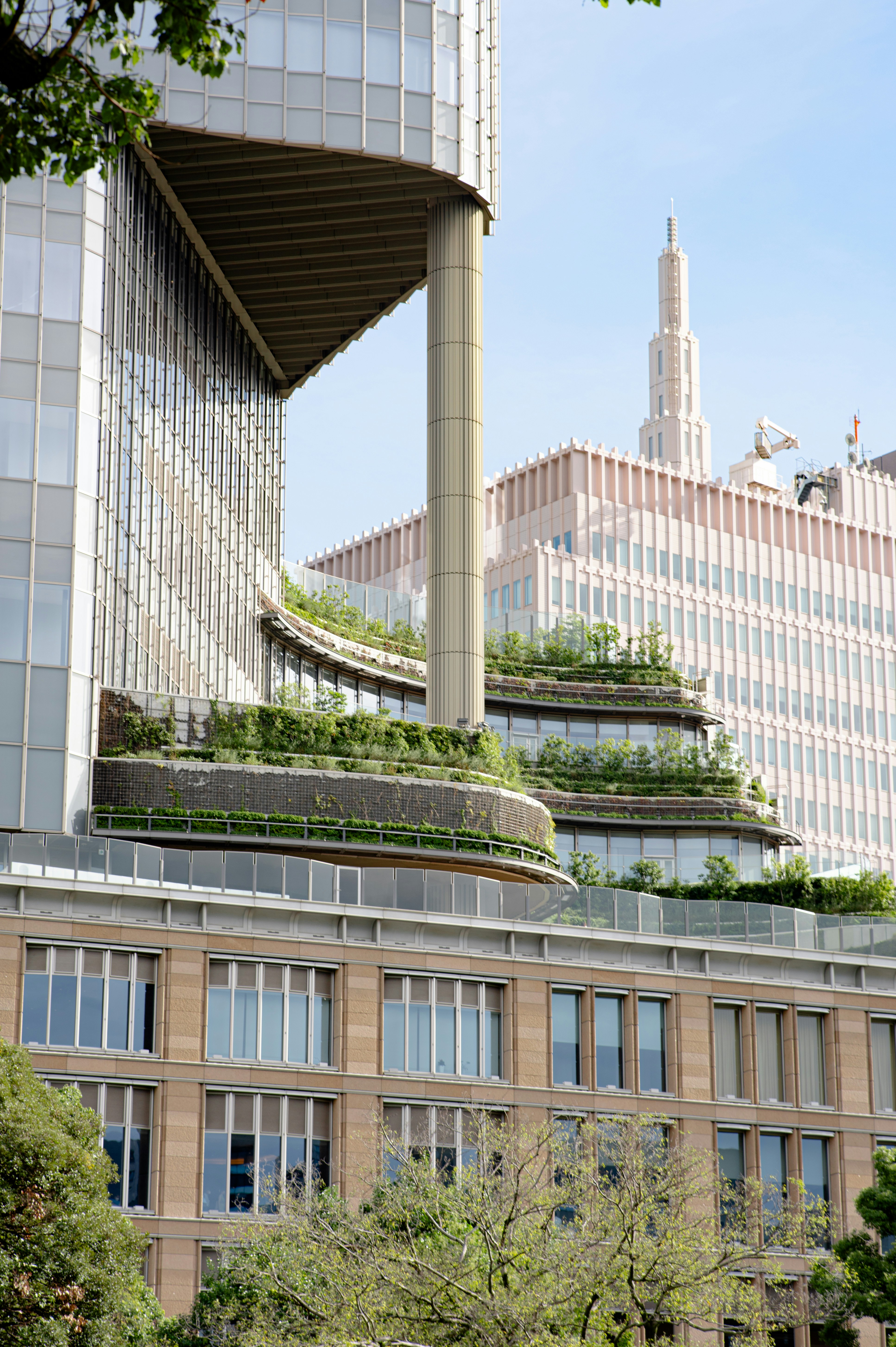 A tall building with a green roof and a spiral staircase photo – Free ...