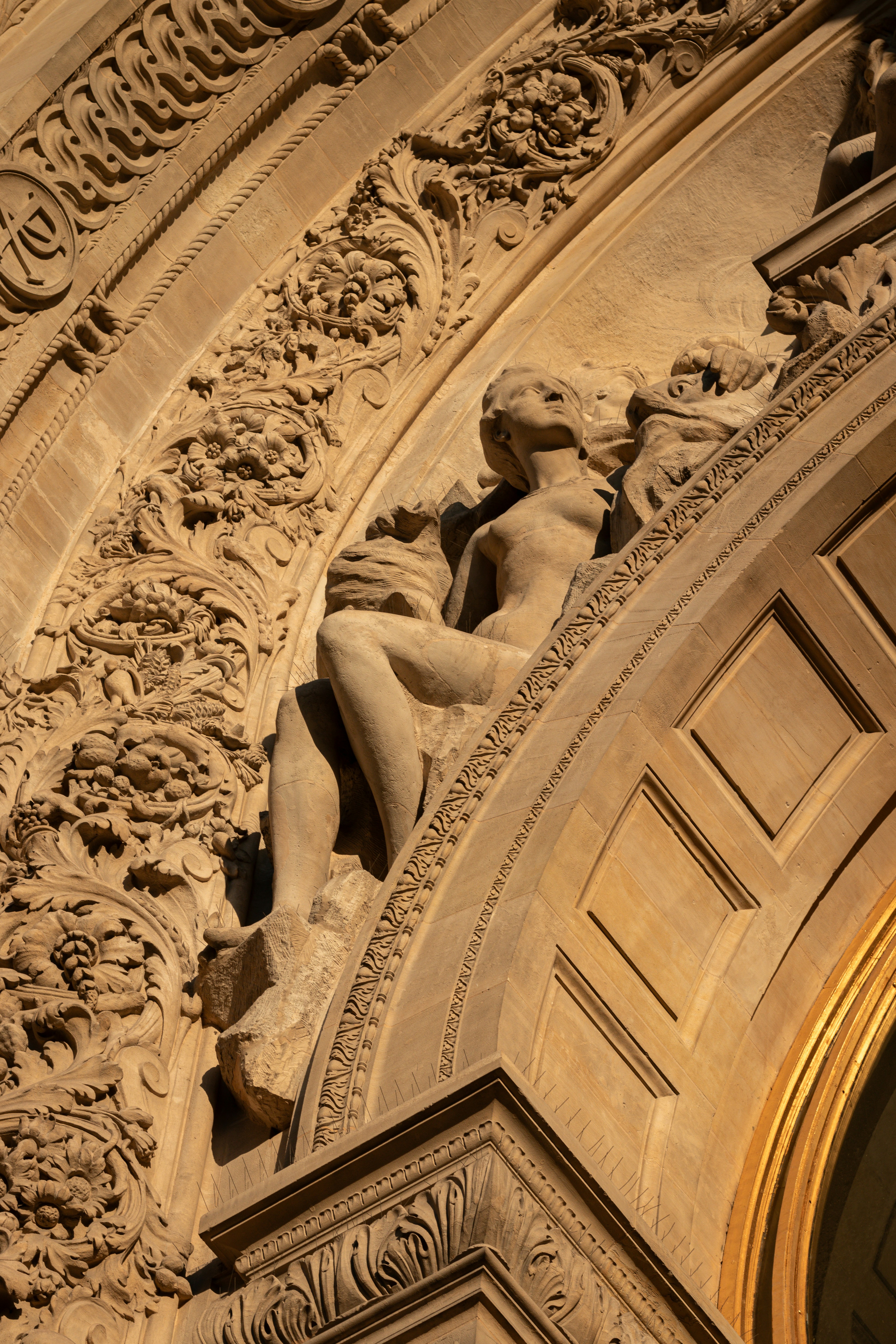 Stone Nymph Upsweep: Carved Figure Amid Baroque Ornament