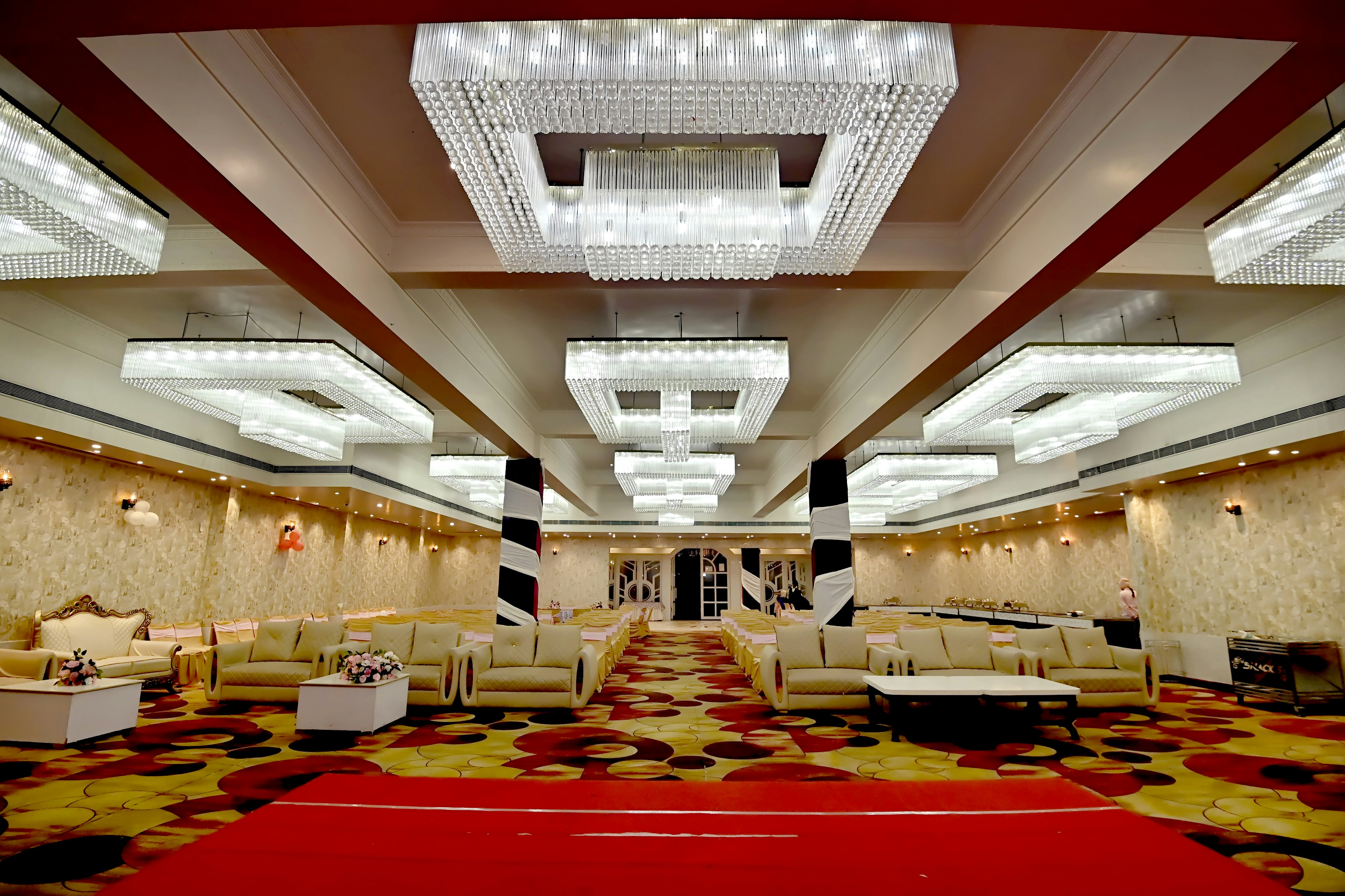 A large room with couches and a red carpet photo – Free Human Image on ...