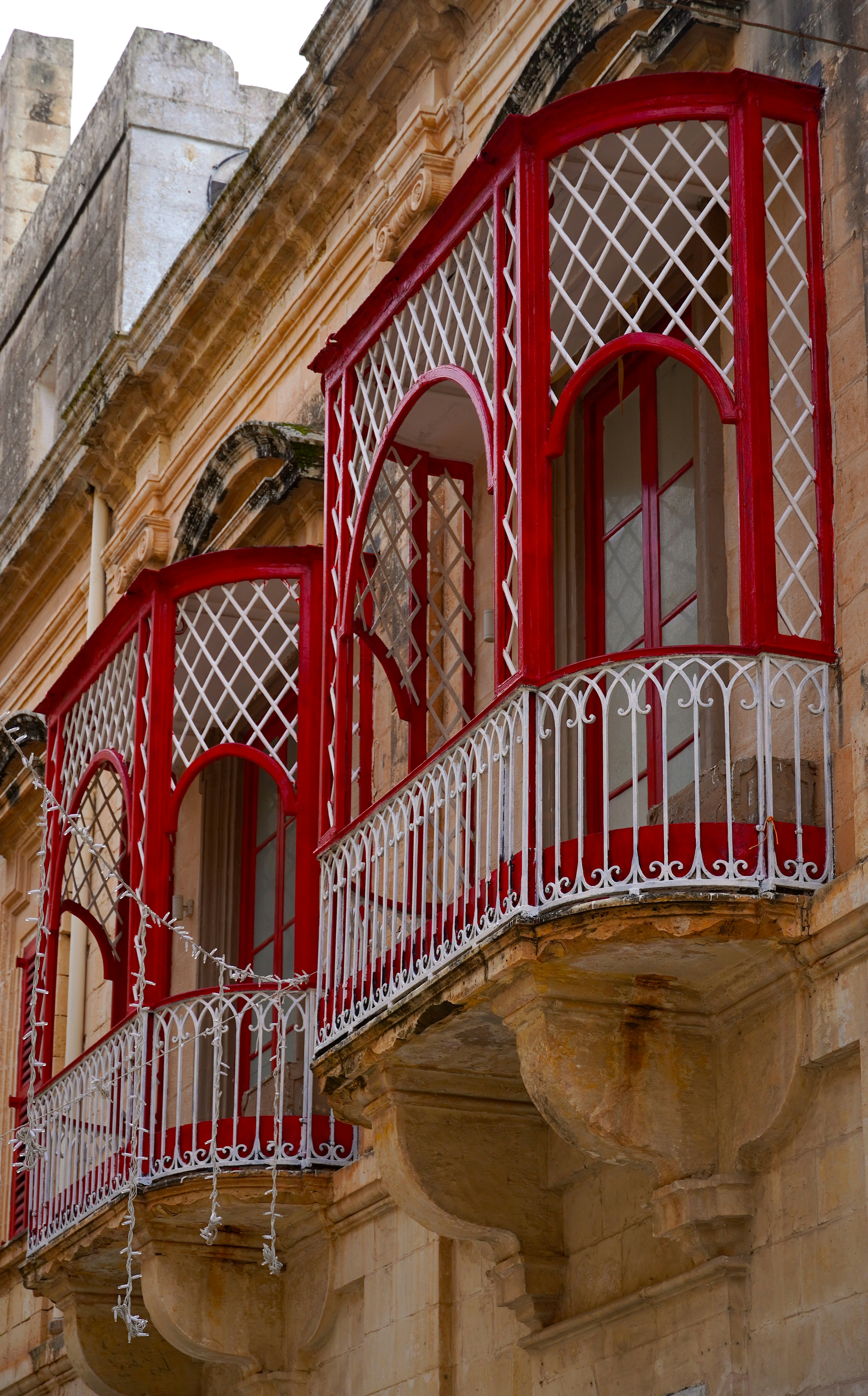 A red and white balcony and balconies of a building photo – Free Malta ...