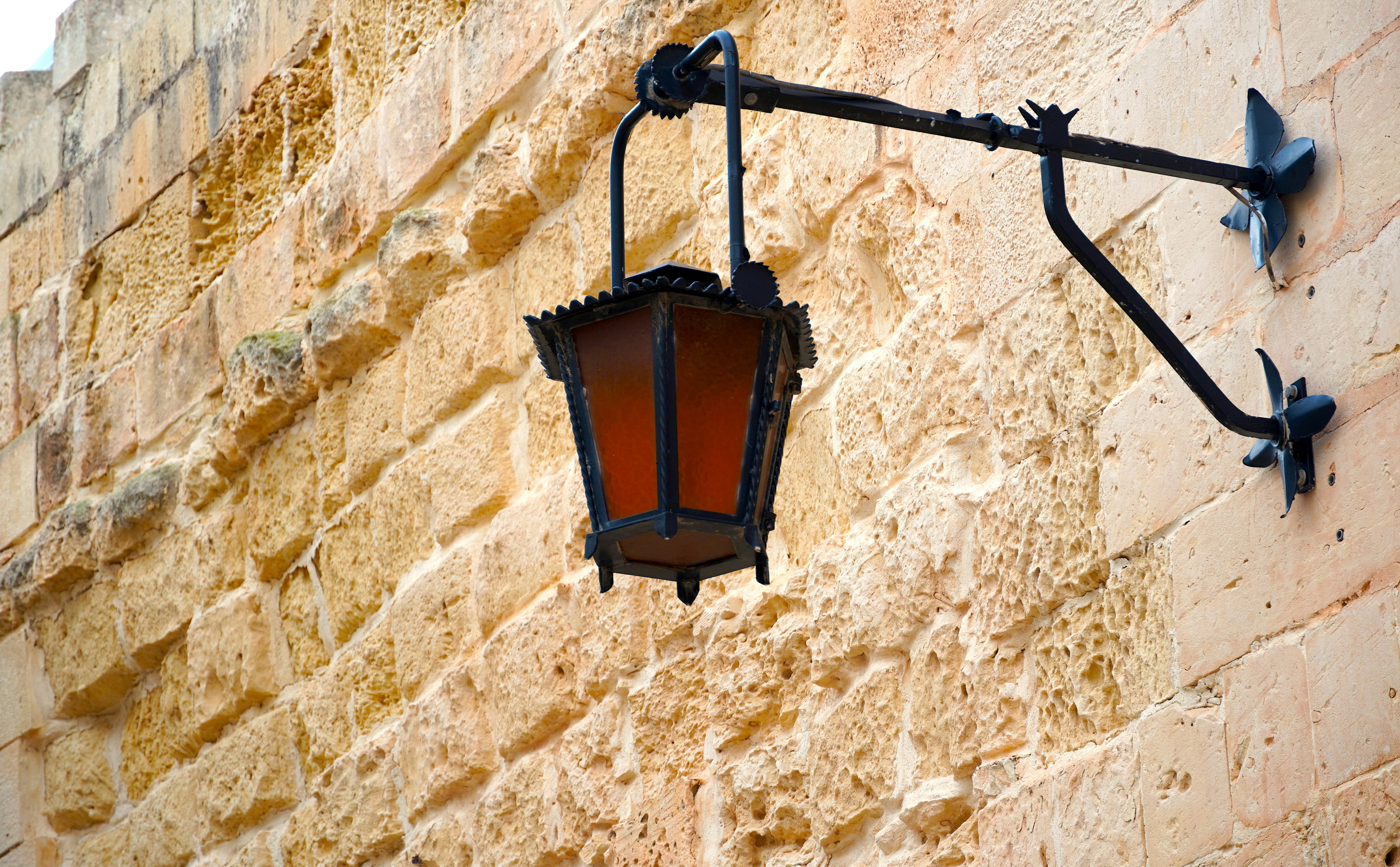 Amber Lantern on a Weathered Stone Wall
