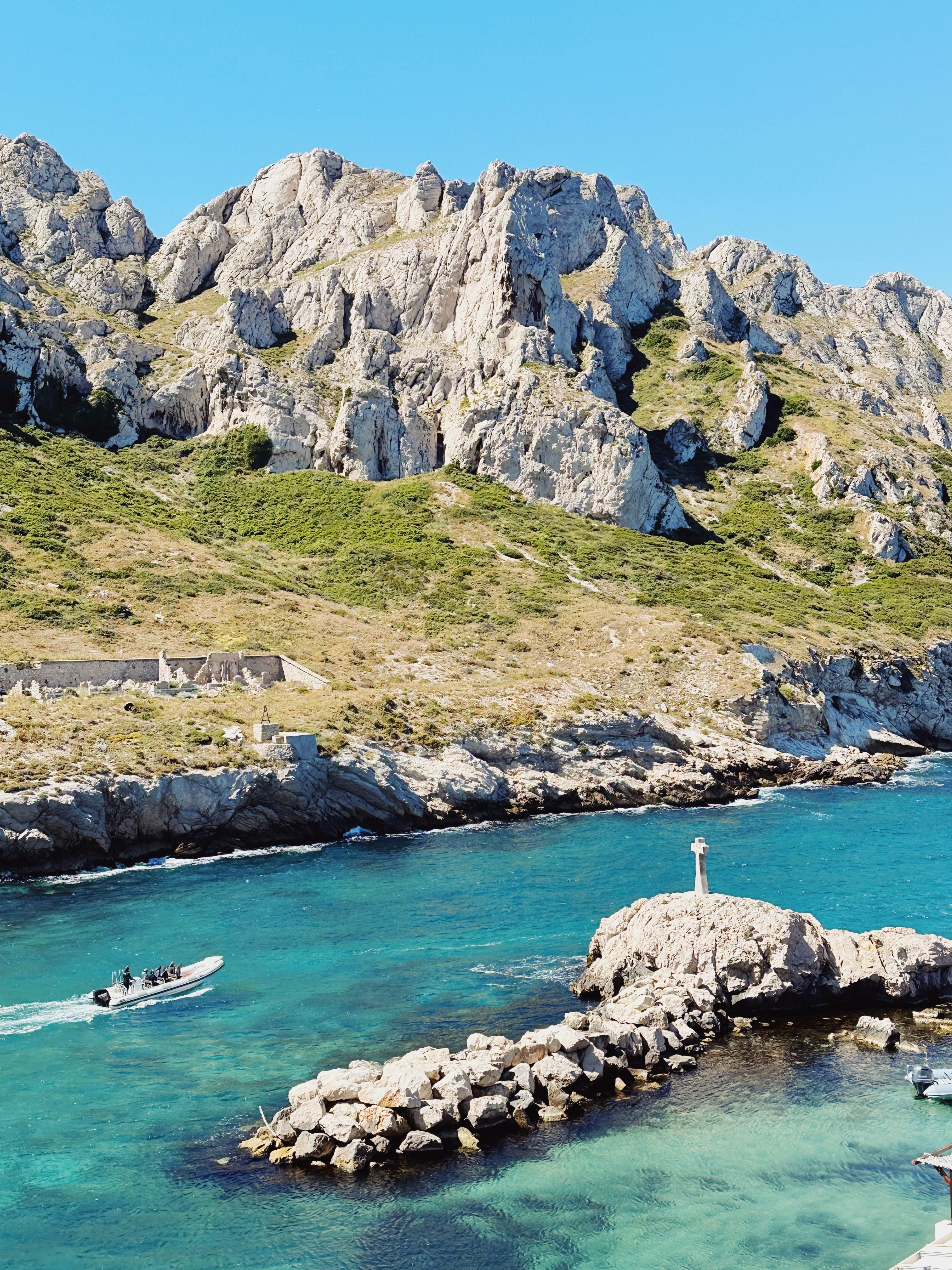 Sentinel on a Turquoise Edge: Lighthouse Over Rugged Cliffs
