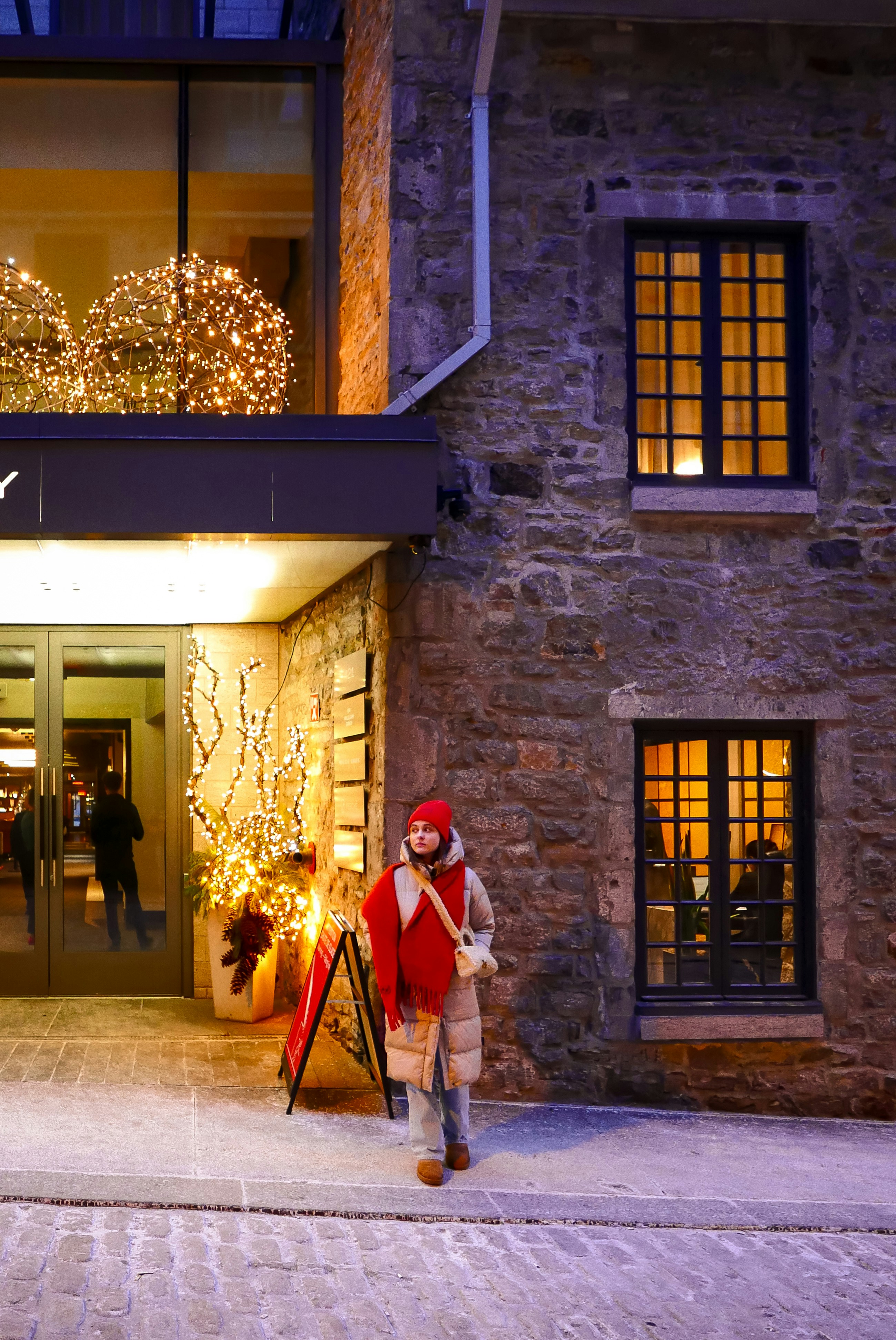 A person walking out of a building at night photo – Free Portrait Image ...