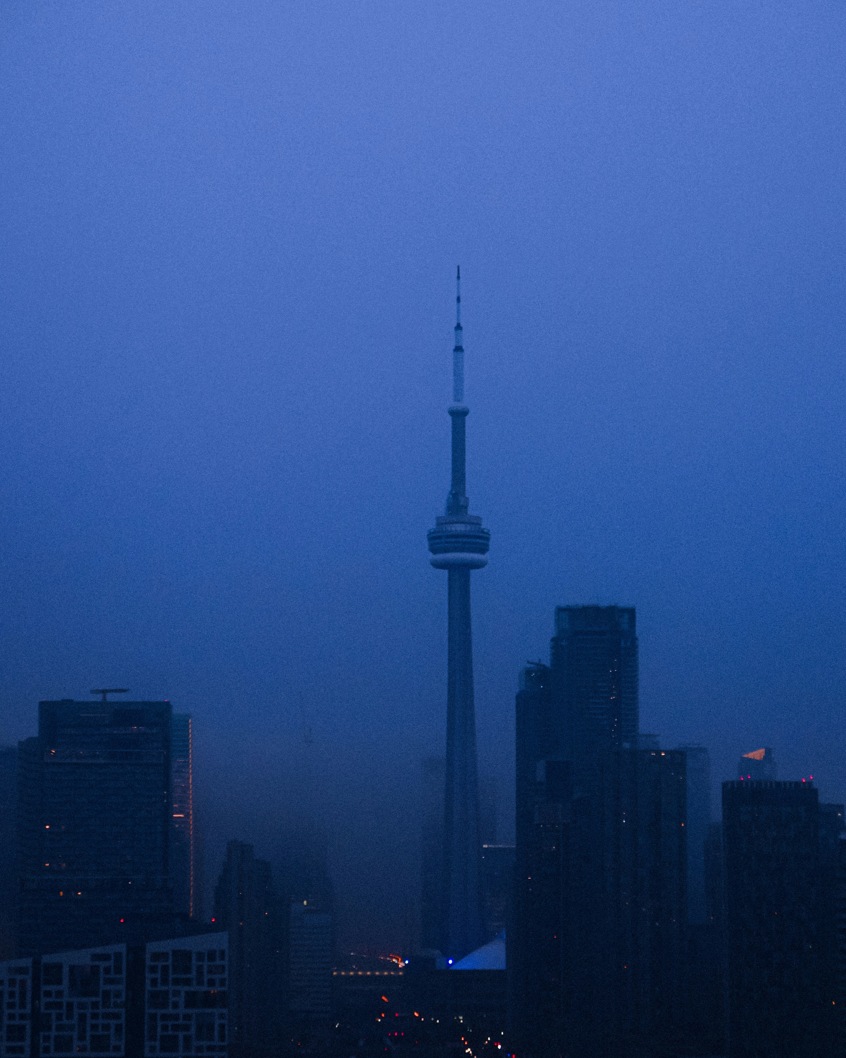 Blue Hour Crown: CN Tower Anchors a Fog-Draped Toronto Skyline