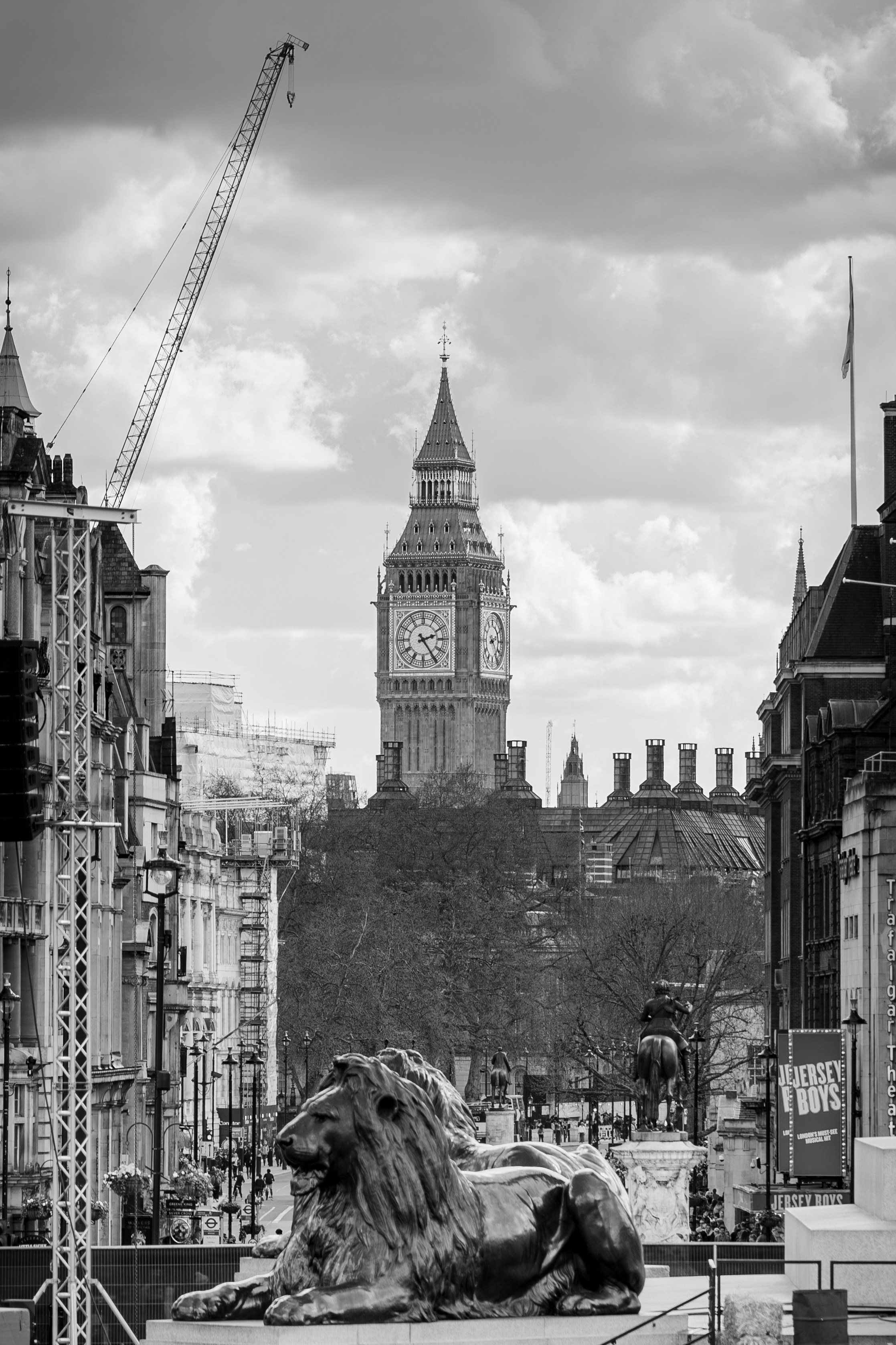 Clocktower Over Westminster: A Black-and-White Street Scene with a Reclining Lion